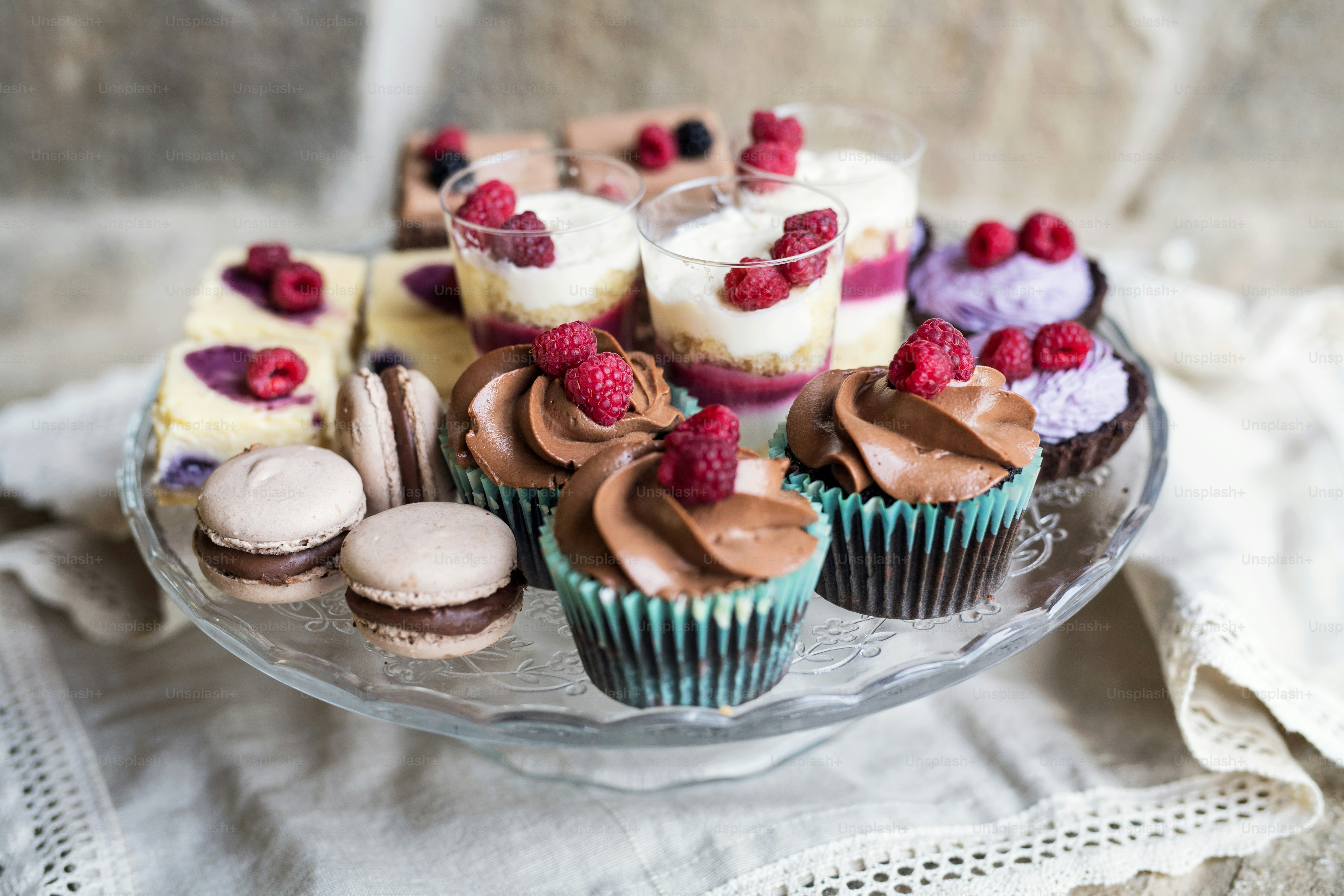 A selection of colorful and delicious cake desserts on tray on table ...