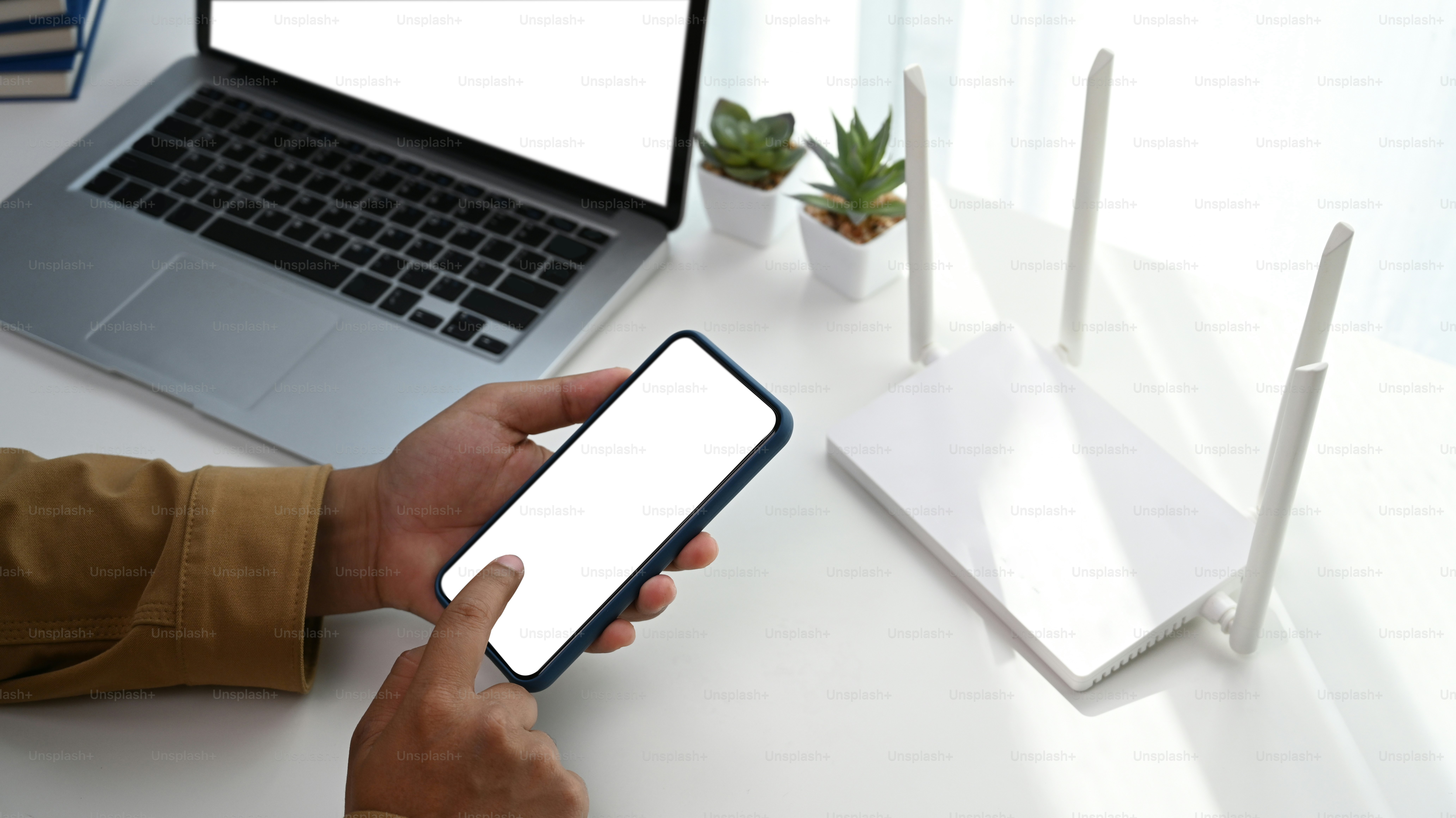 Close up view of man using mobile phone connecting wireless at home ...