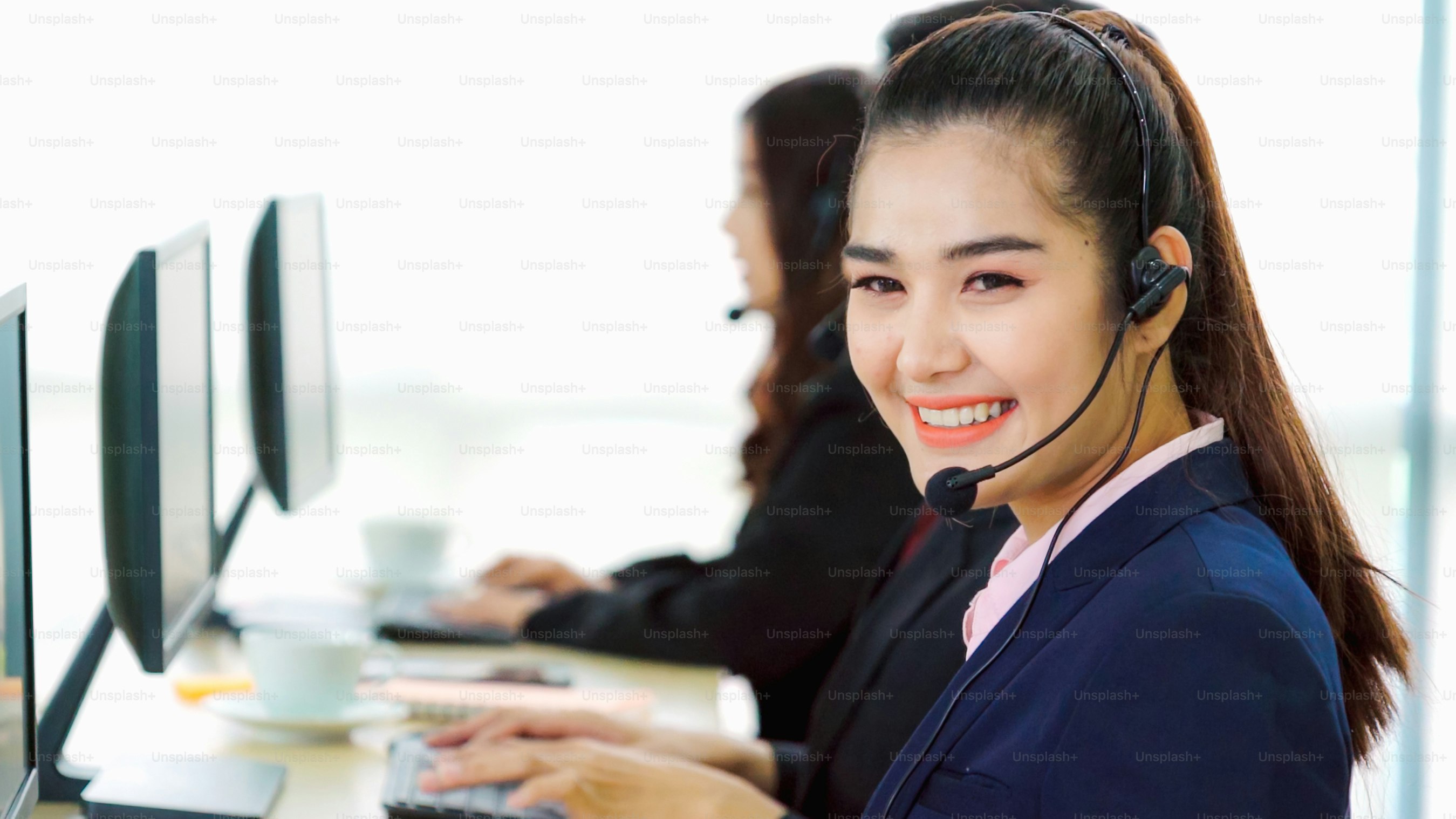 Business people wearing headset working in office to support remote ...