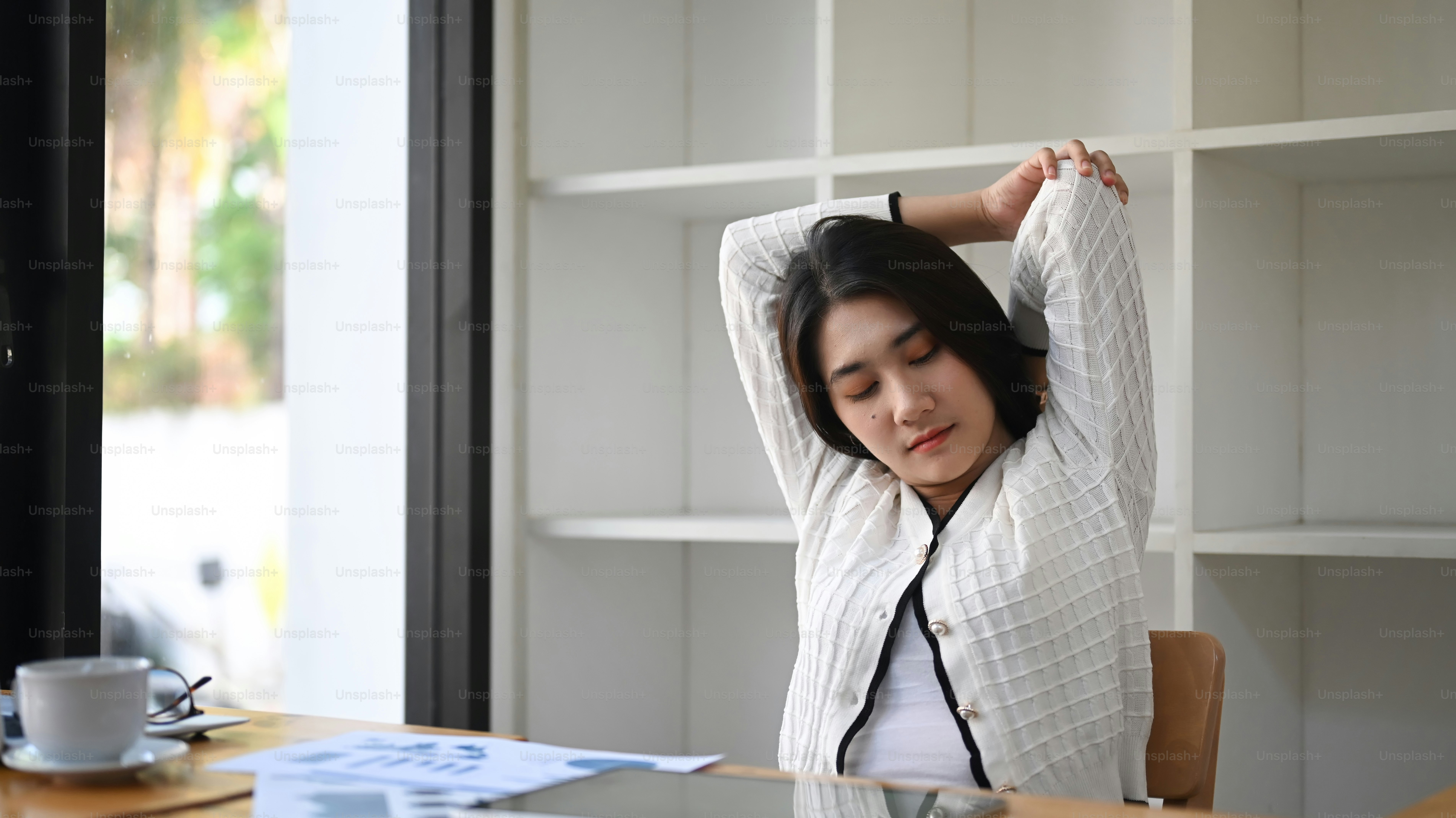 Businesswoman relaxing at comfortable office chair and Stretching her ...