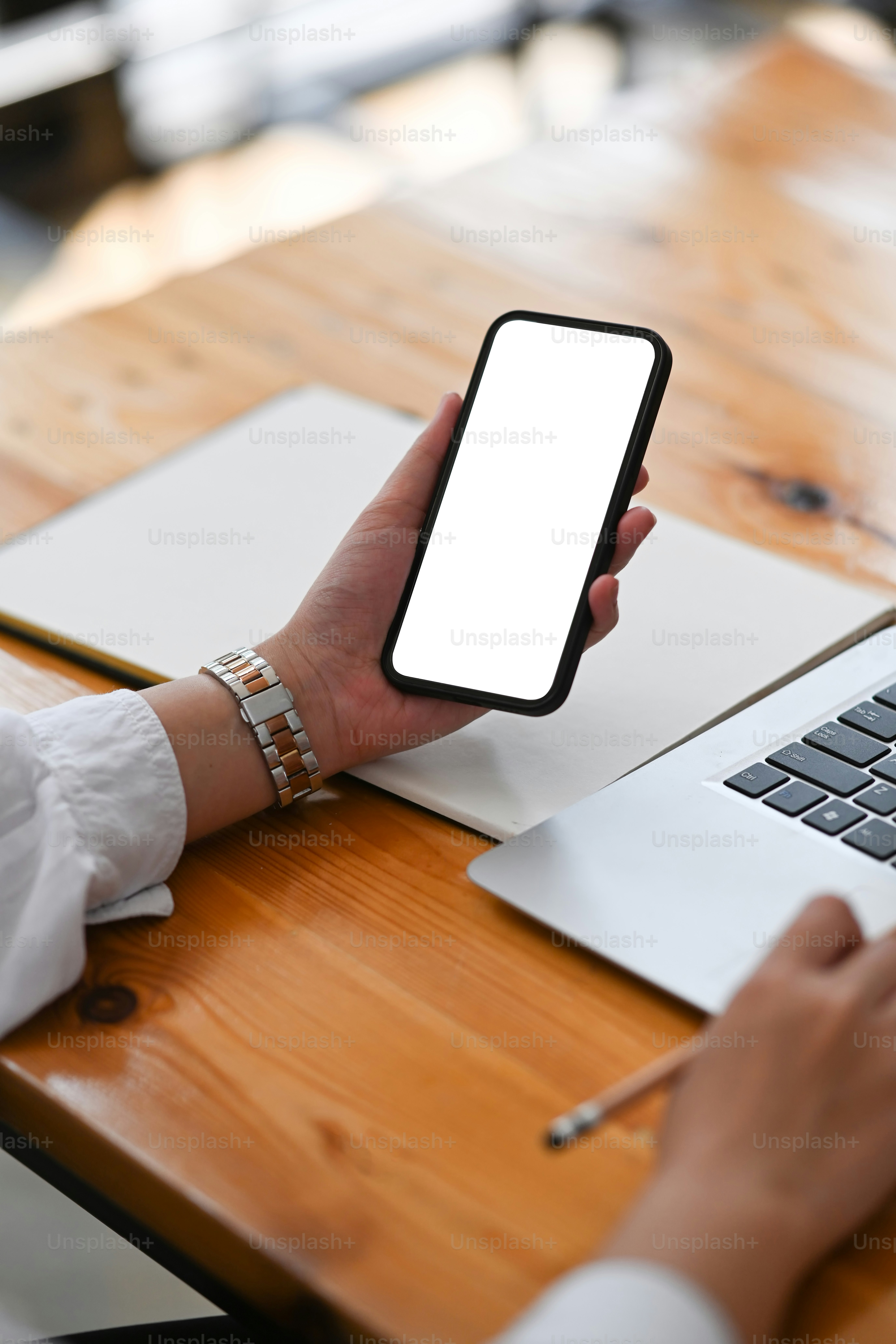 Close up view of young woman using smart phone during working at office ...