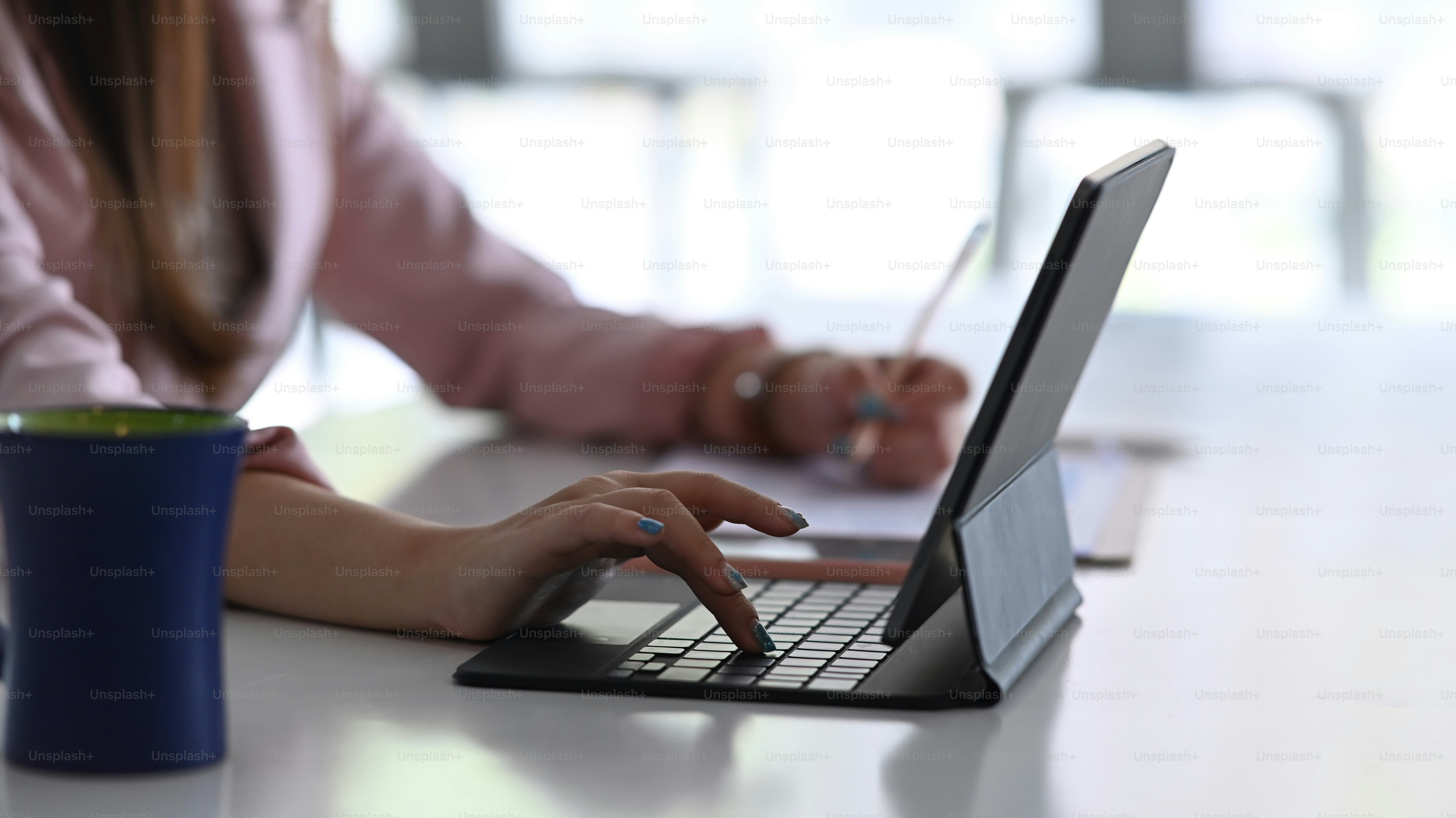 Close up view businesswoman typing on keyboard of tablet computer and ...