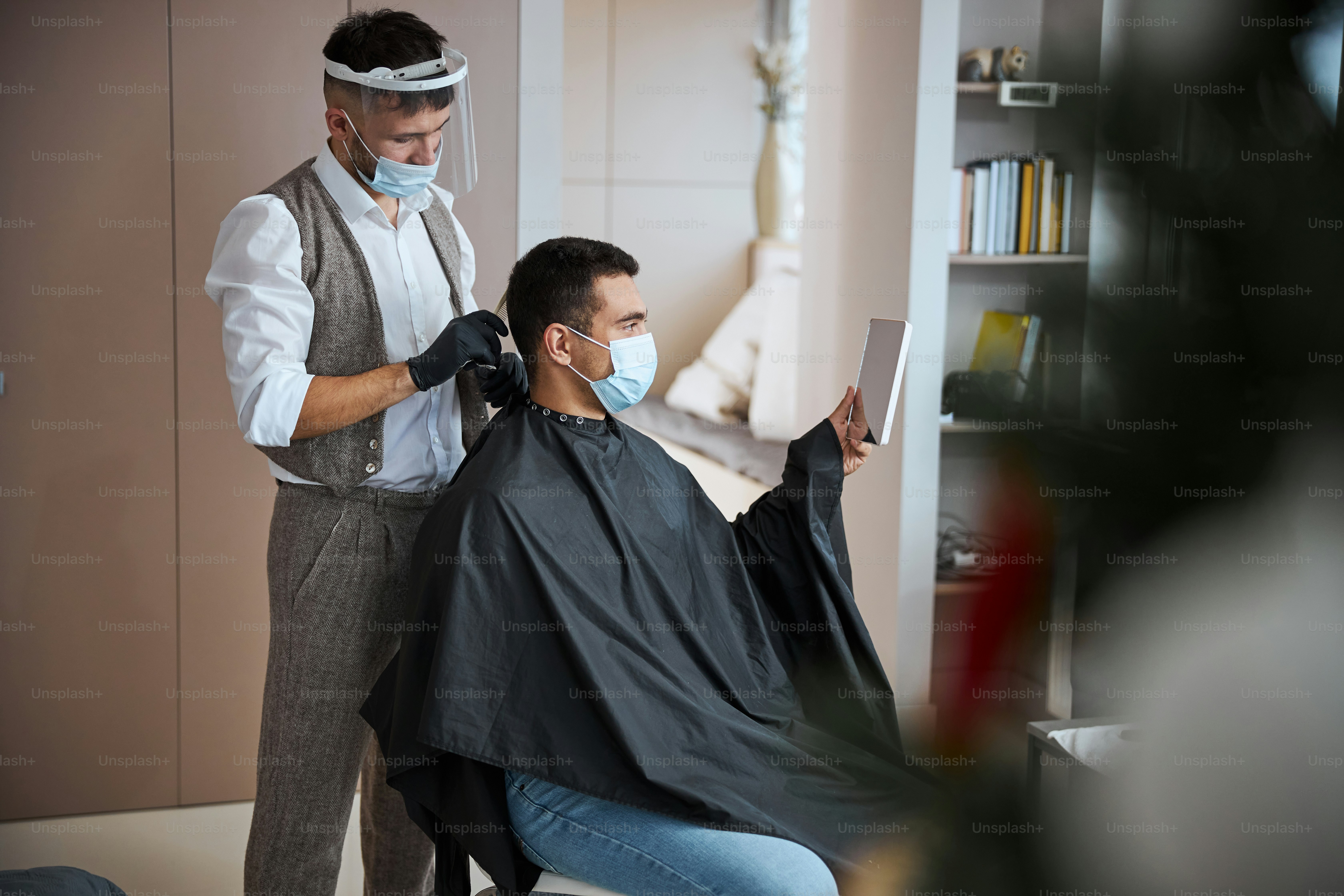 Waist up side view portrait of professional hair stylist in black ...