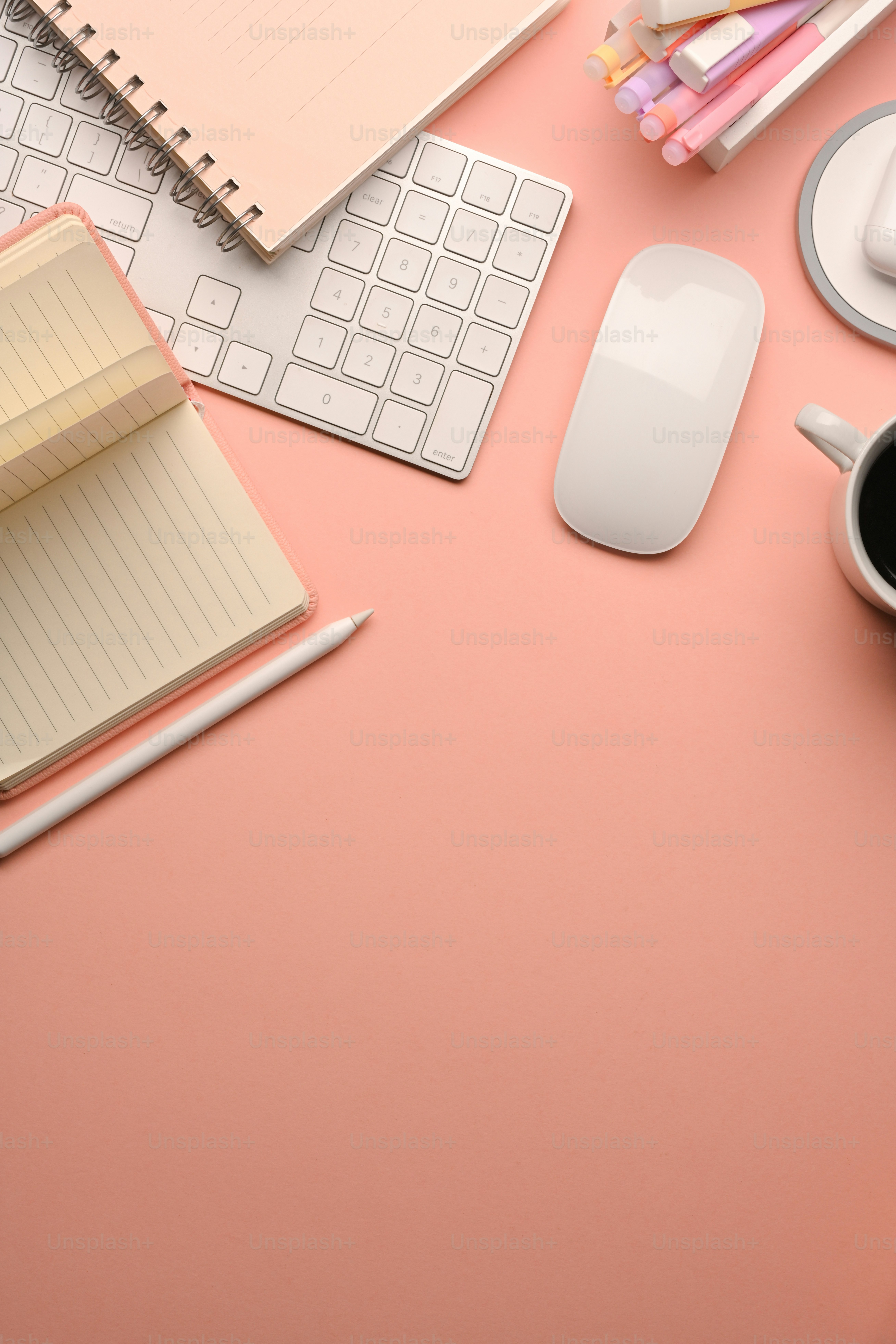 Cropped shot of pink creative study table with computer keyboard, mouse ...
