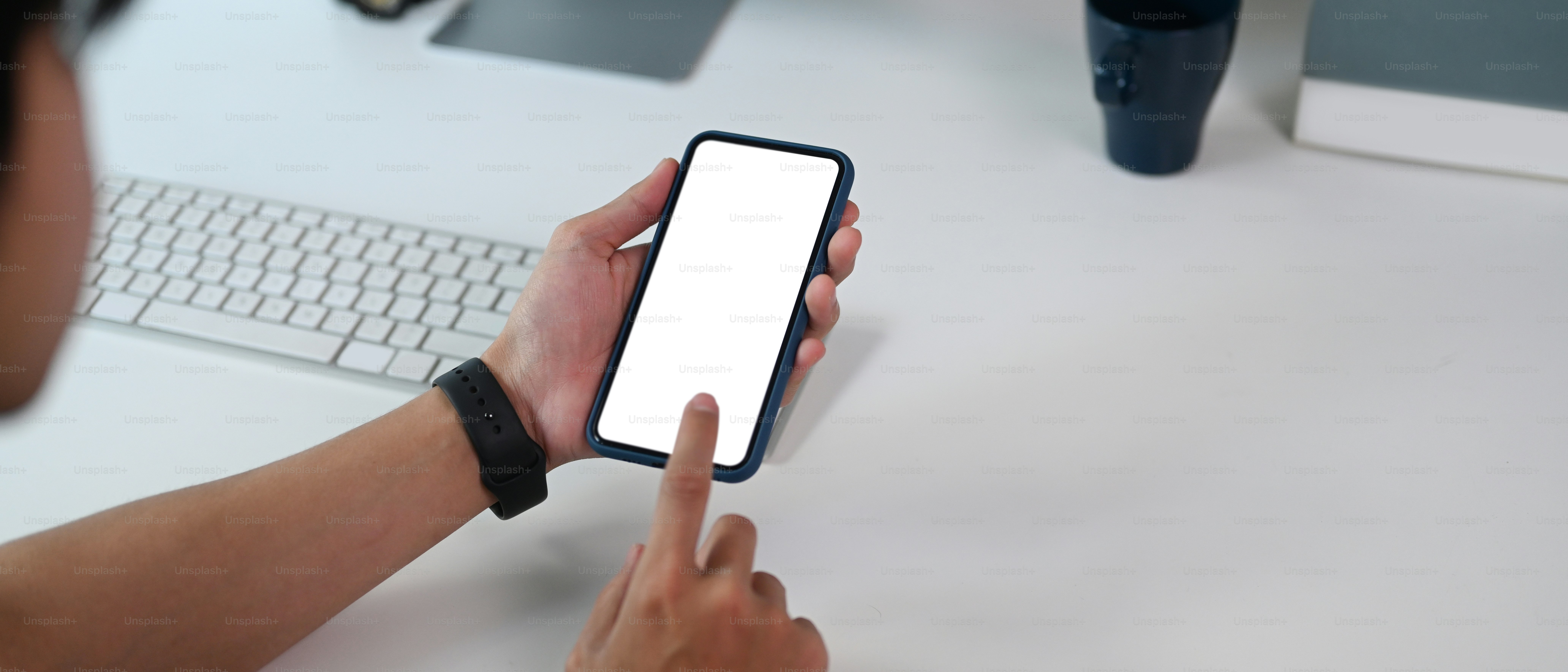 Horizontal photo of man using smart phone during working at his office ...