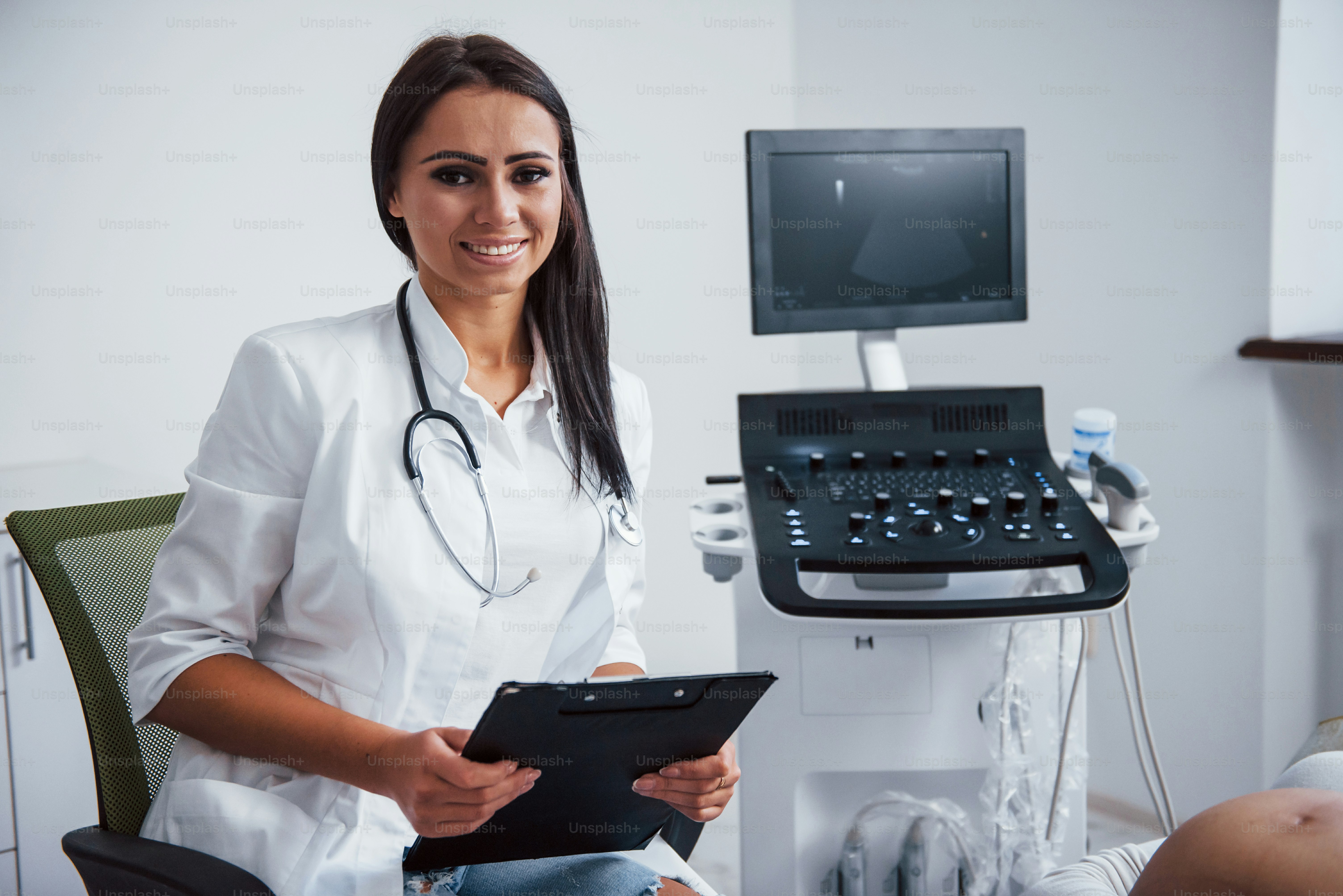Portrait of obstetric doctor that sits in the clinic room with ...