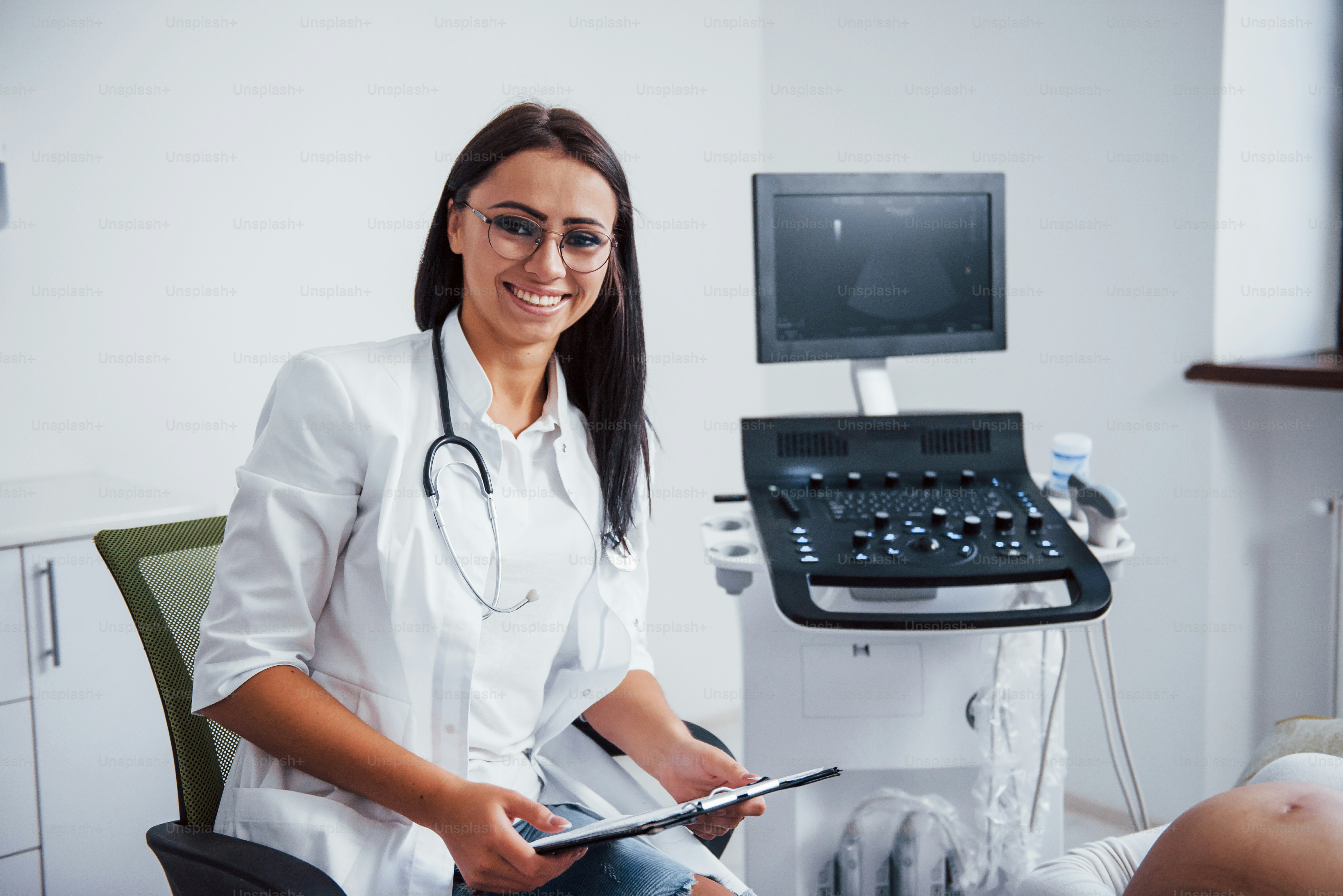 Portrait of obstetric doctor that sits in the clinic room with ...