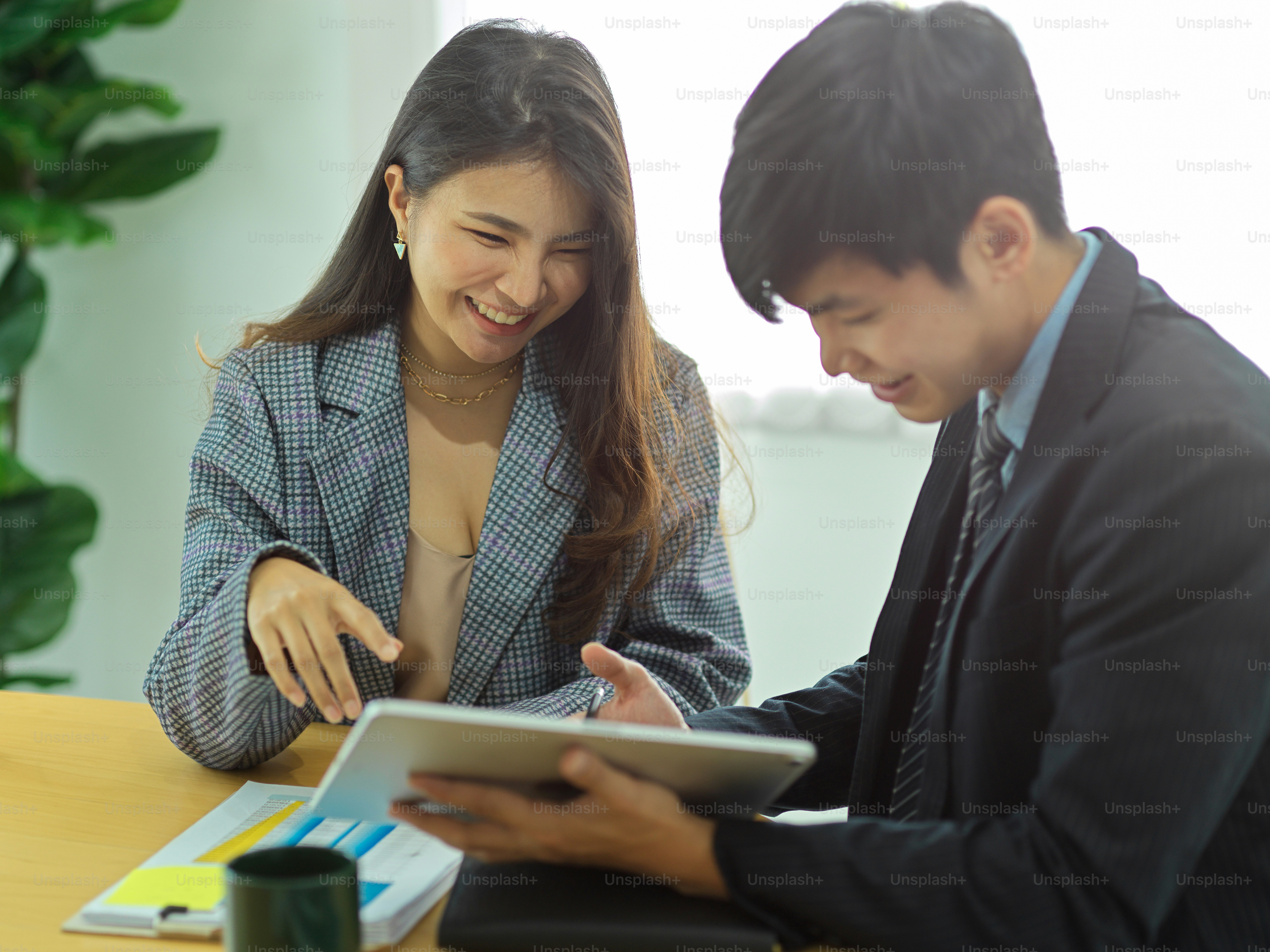 Portraits of businesspeople having happy conversations while consulting ...