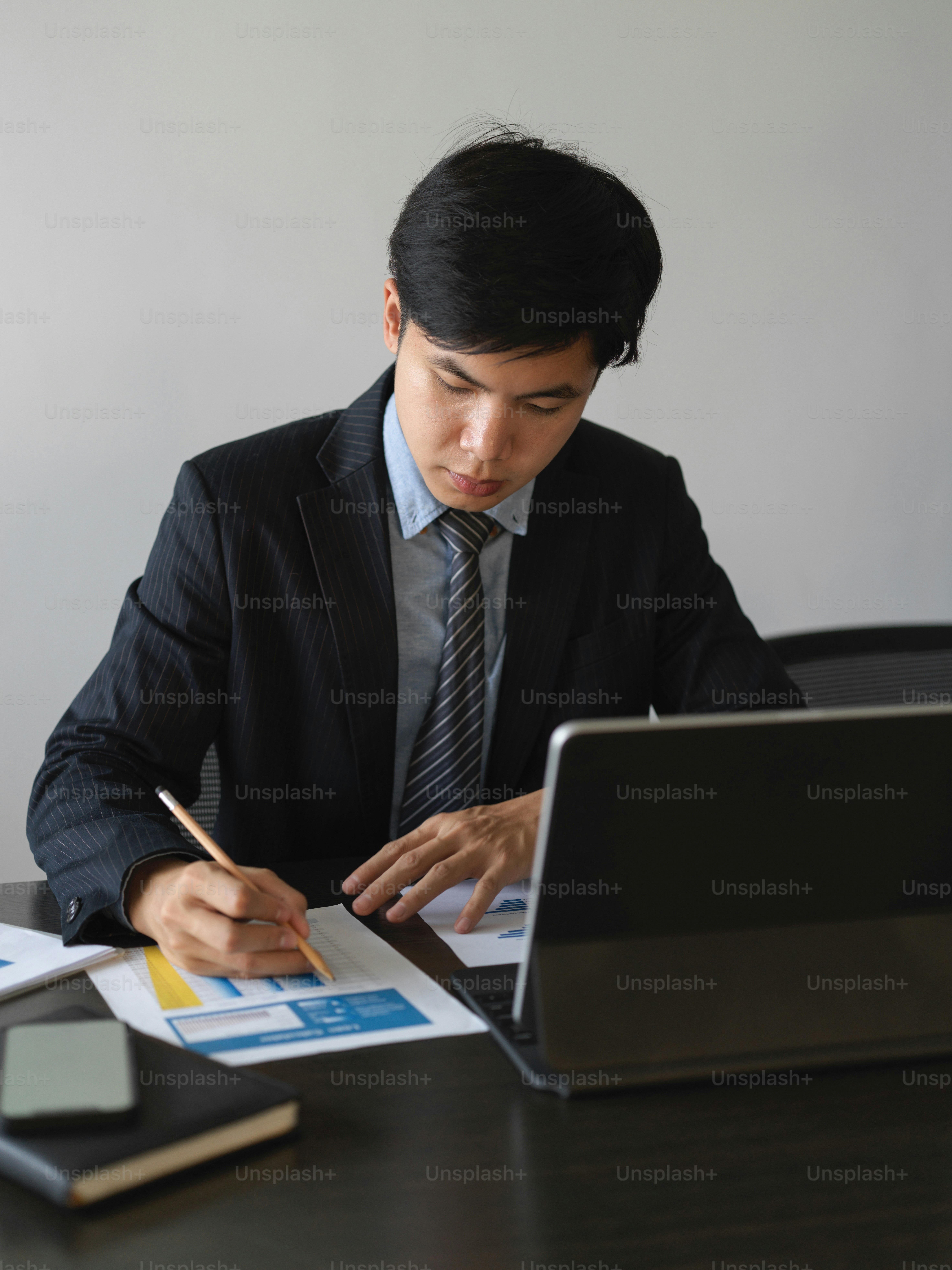 Portrait of businessman analysing on business paperwork on the table ...