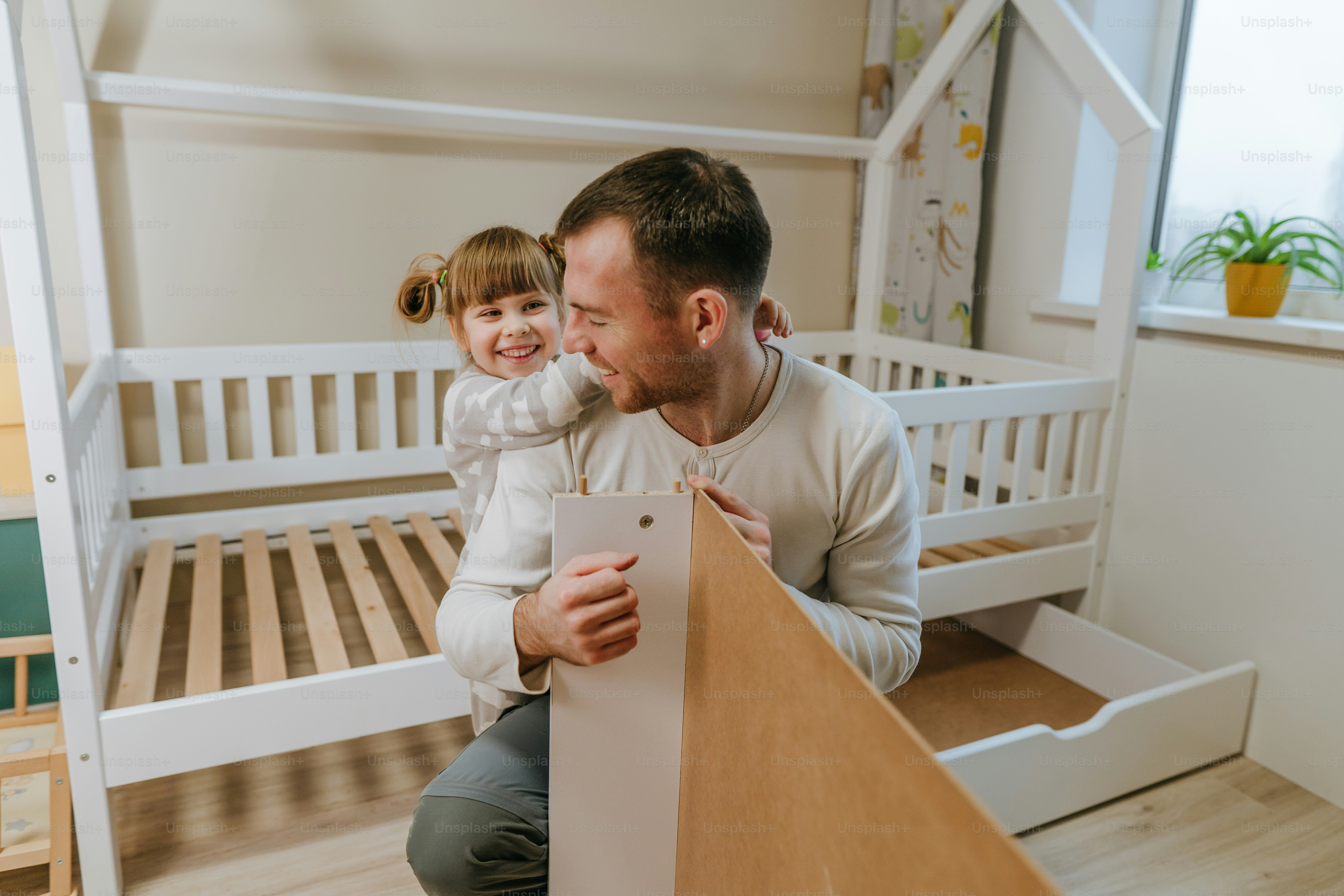 Little 4-years girl helps her father assemble or fixing the drawer of ...