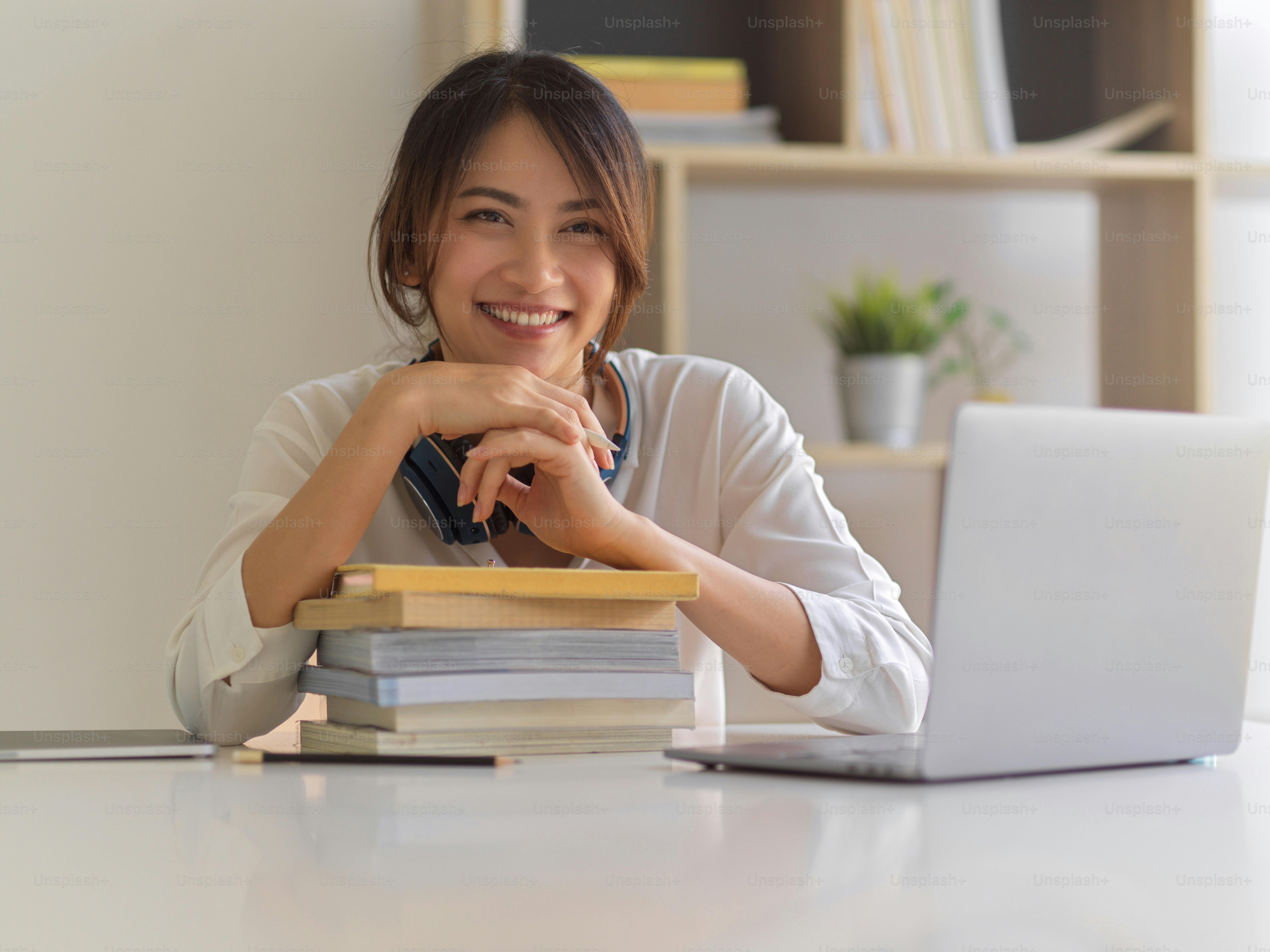 Portrait of female university student smiling to camera while sitting ...