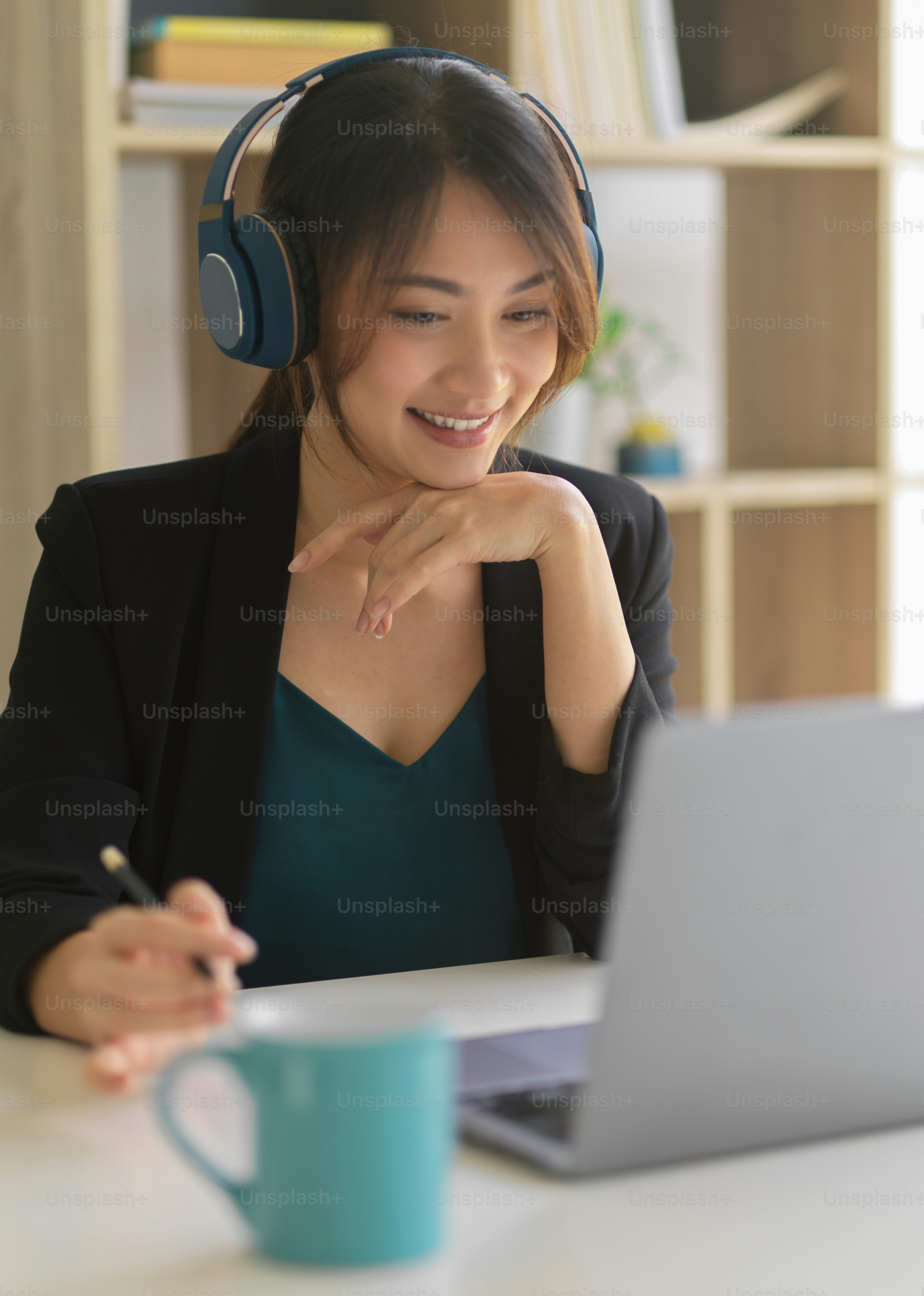 Cropped shot of happy businesswoman smiling and using headphone while ...