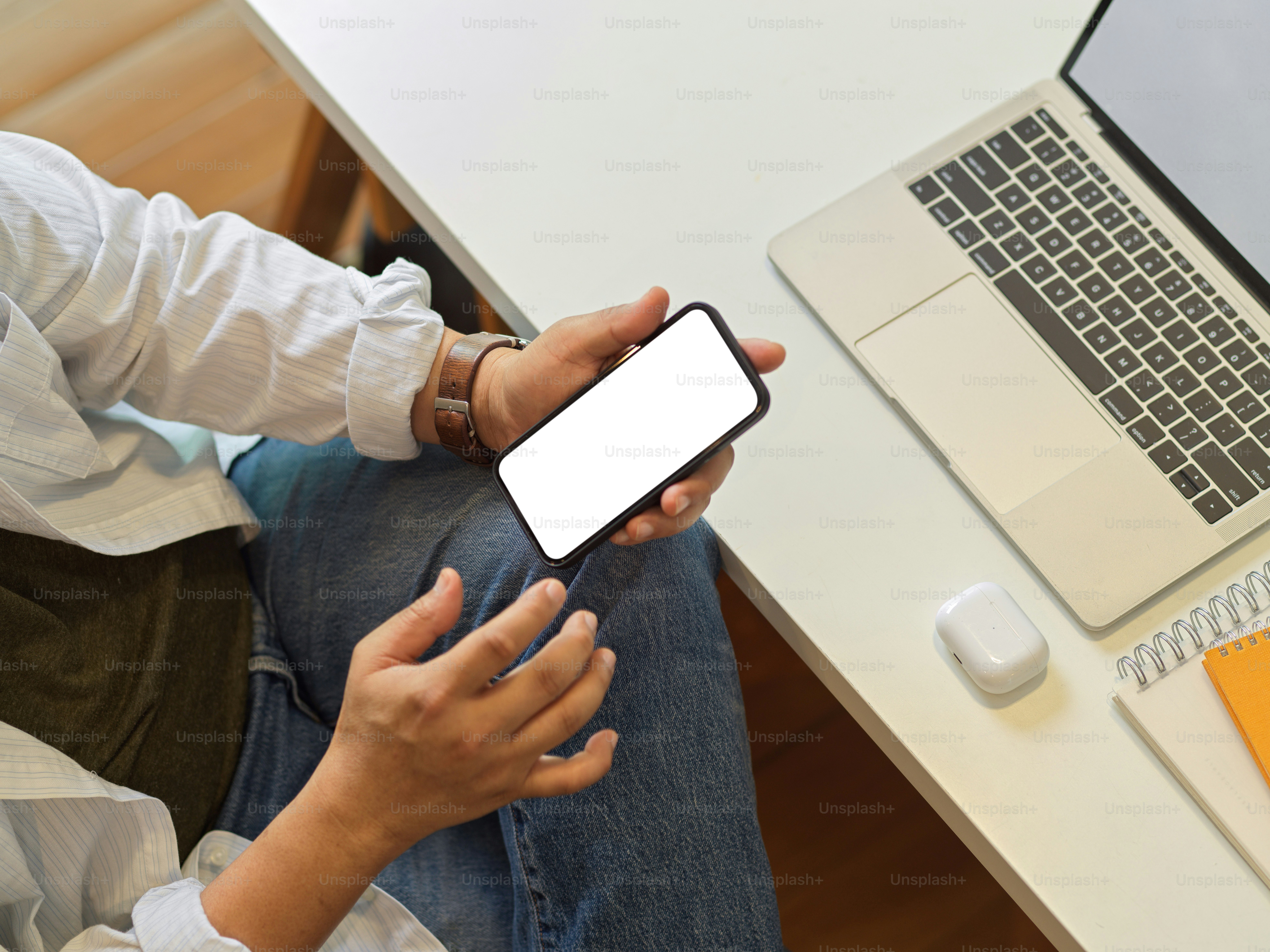 Overhead shot of businessman using mock up smartphone while relaxed ...