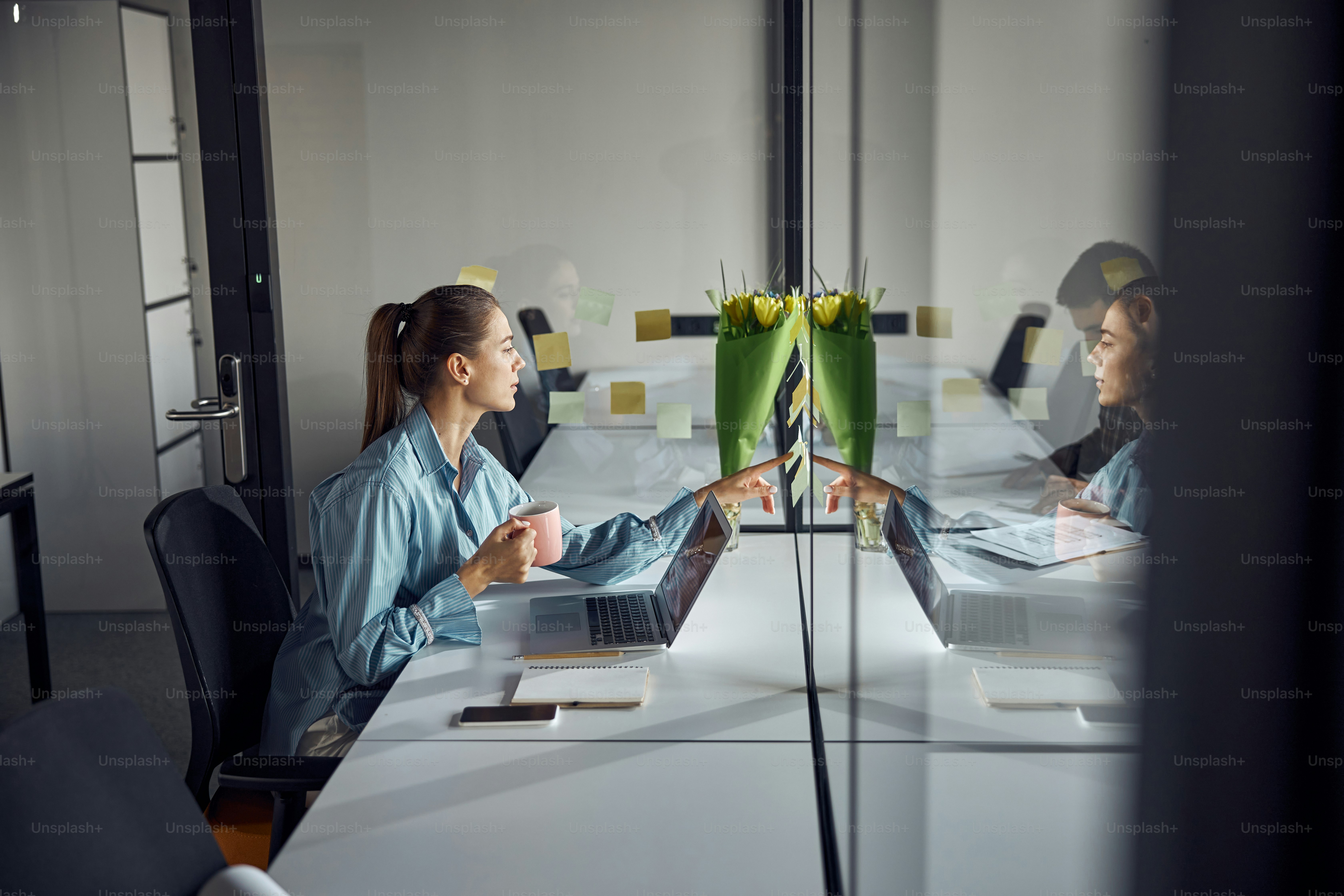 Side view of a serious office worker staring at a sticky note on the ...