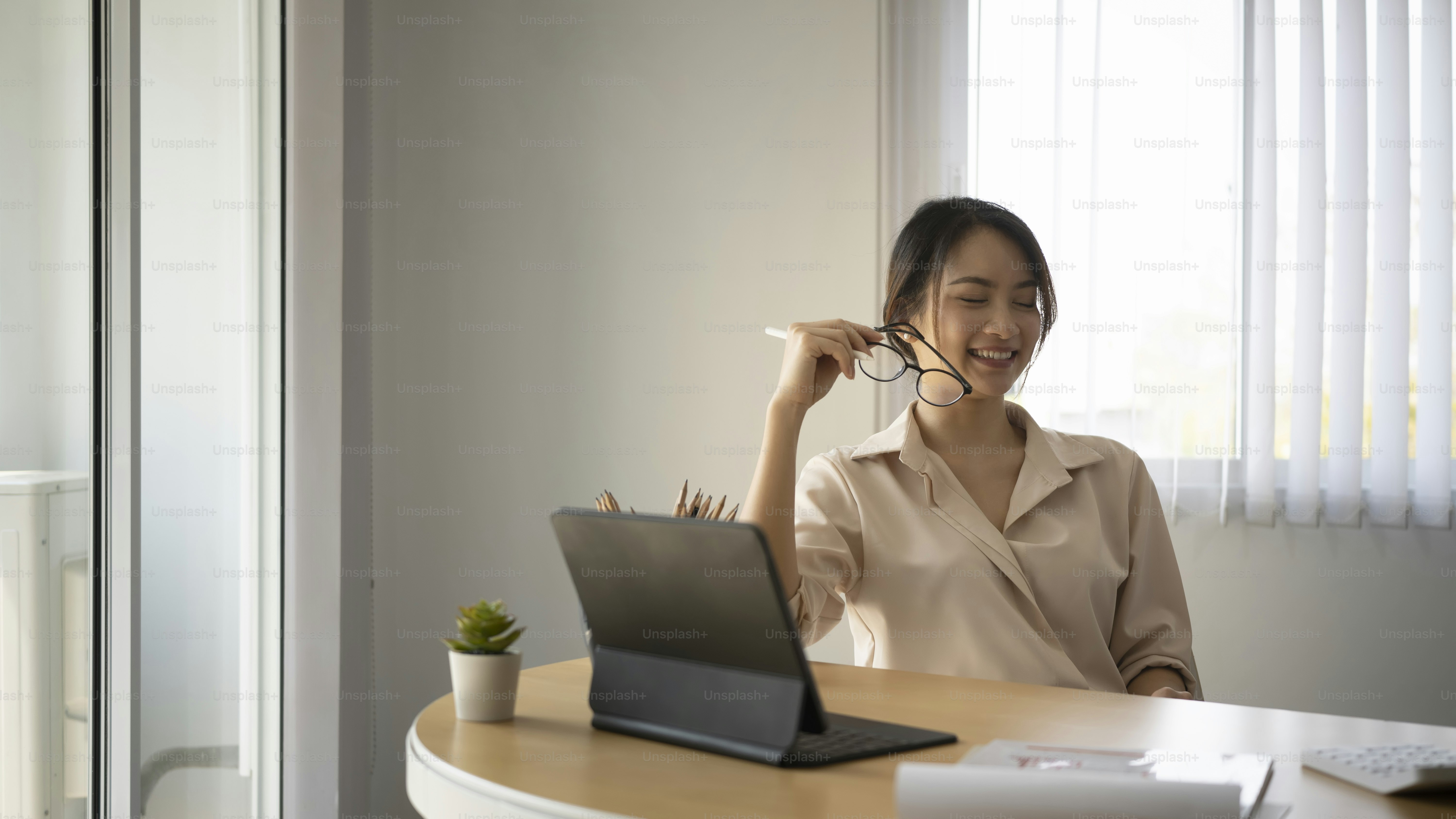 Cheerful young woman office worker relaxing and sitting at her ...