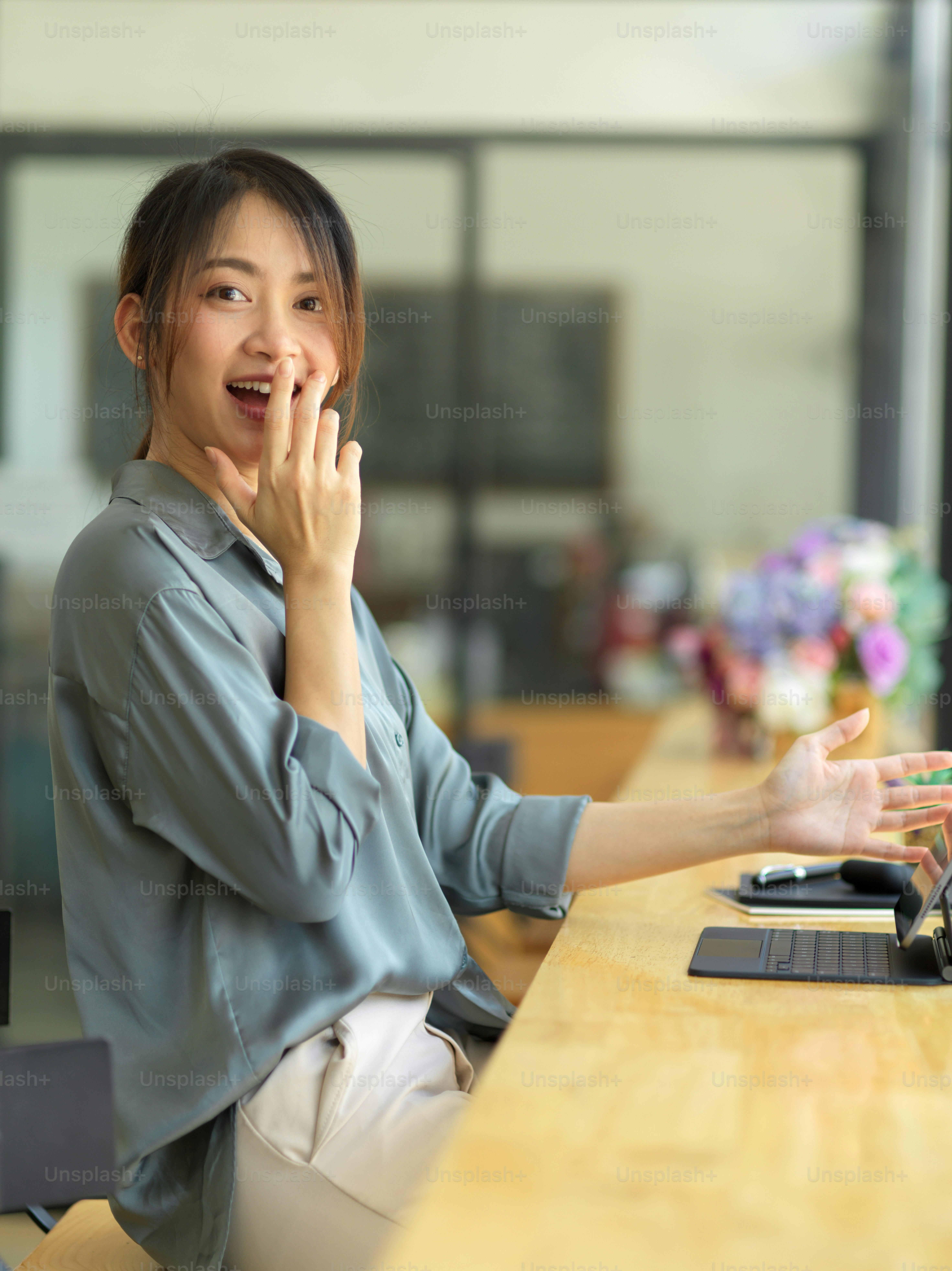 Portrait of young beautiful female feeling surprise while using digital ...