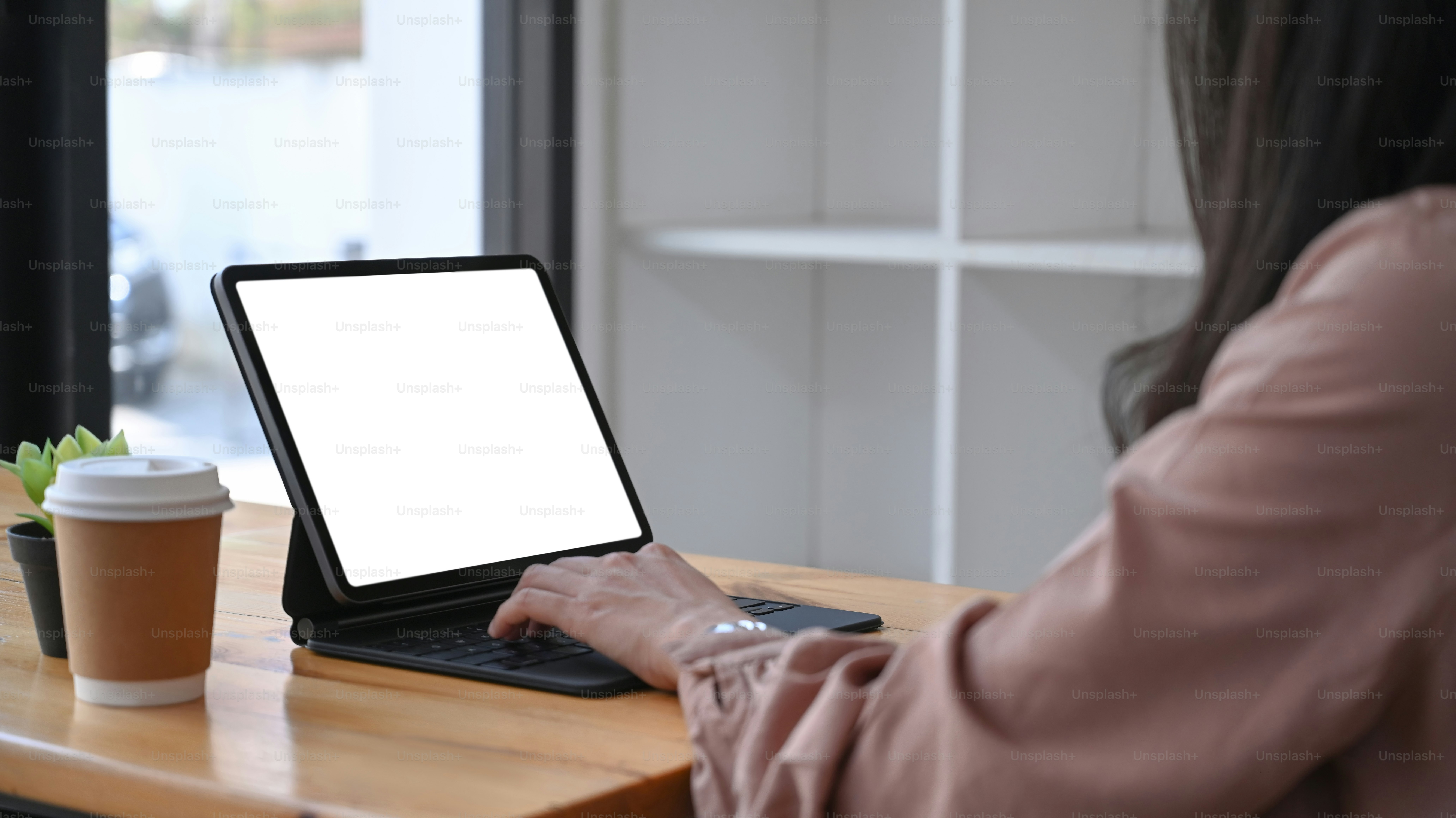 Young businesswoman working on computer tablet at coffee shop. photo ...