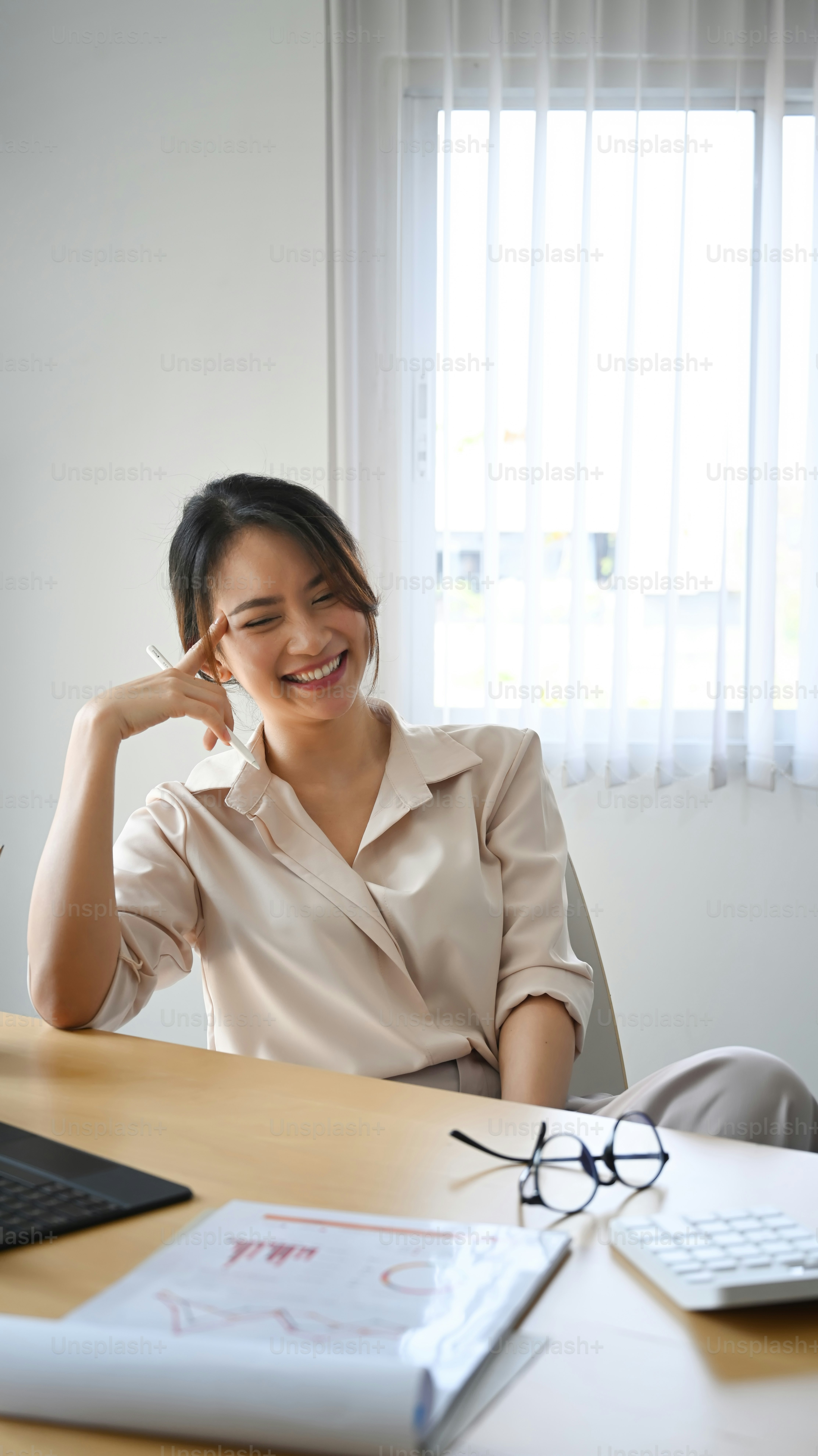 Portrait of happy female accountant sitting at her workplace and ...