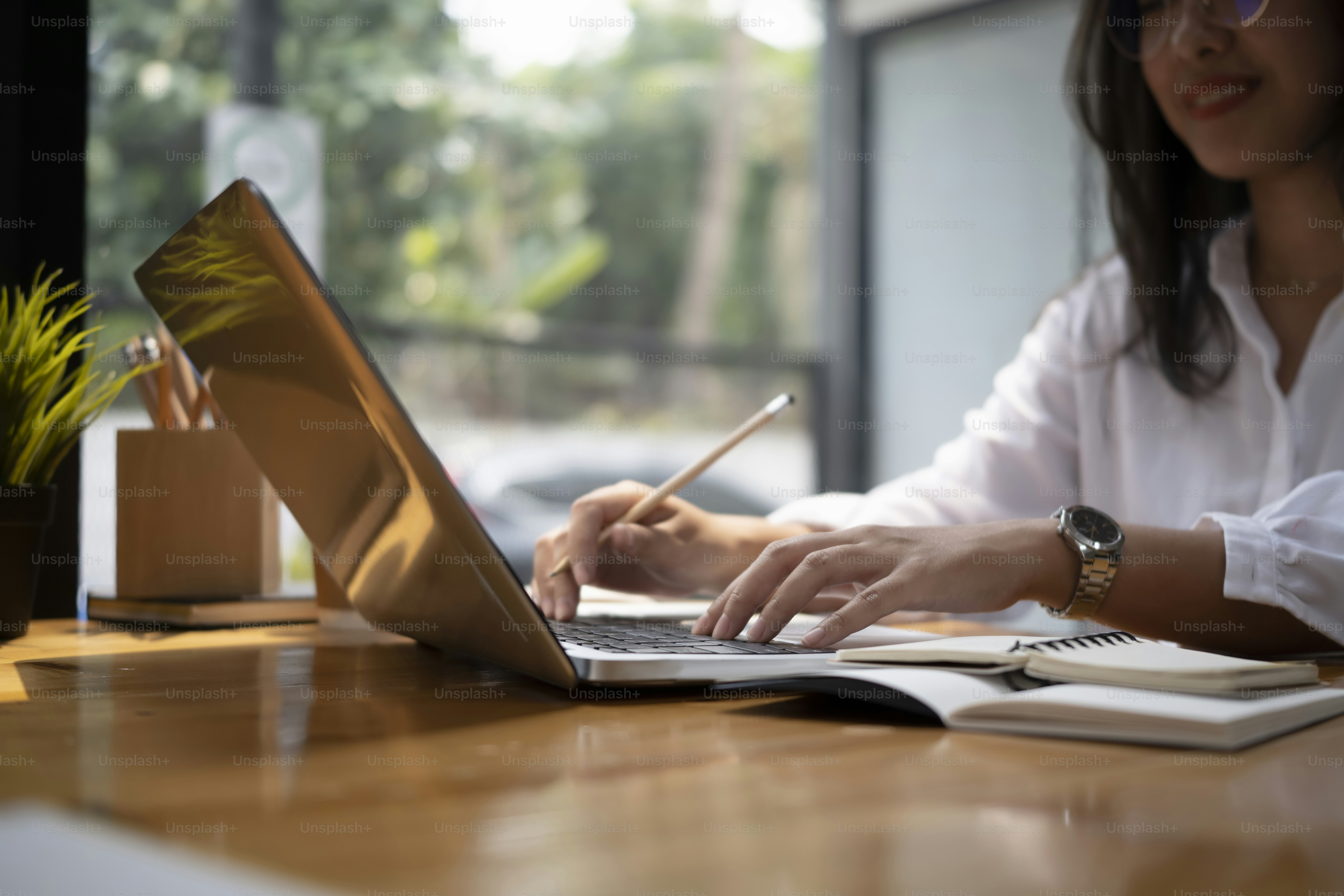 Cropped shot of happy businesswoman working with laptop computer at ...