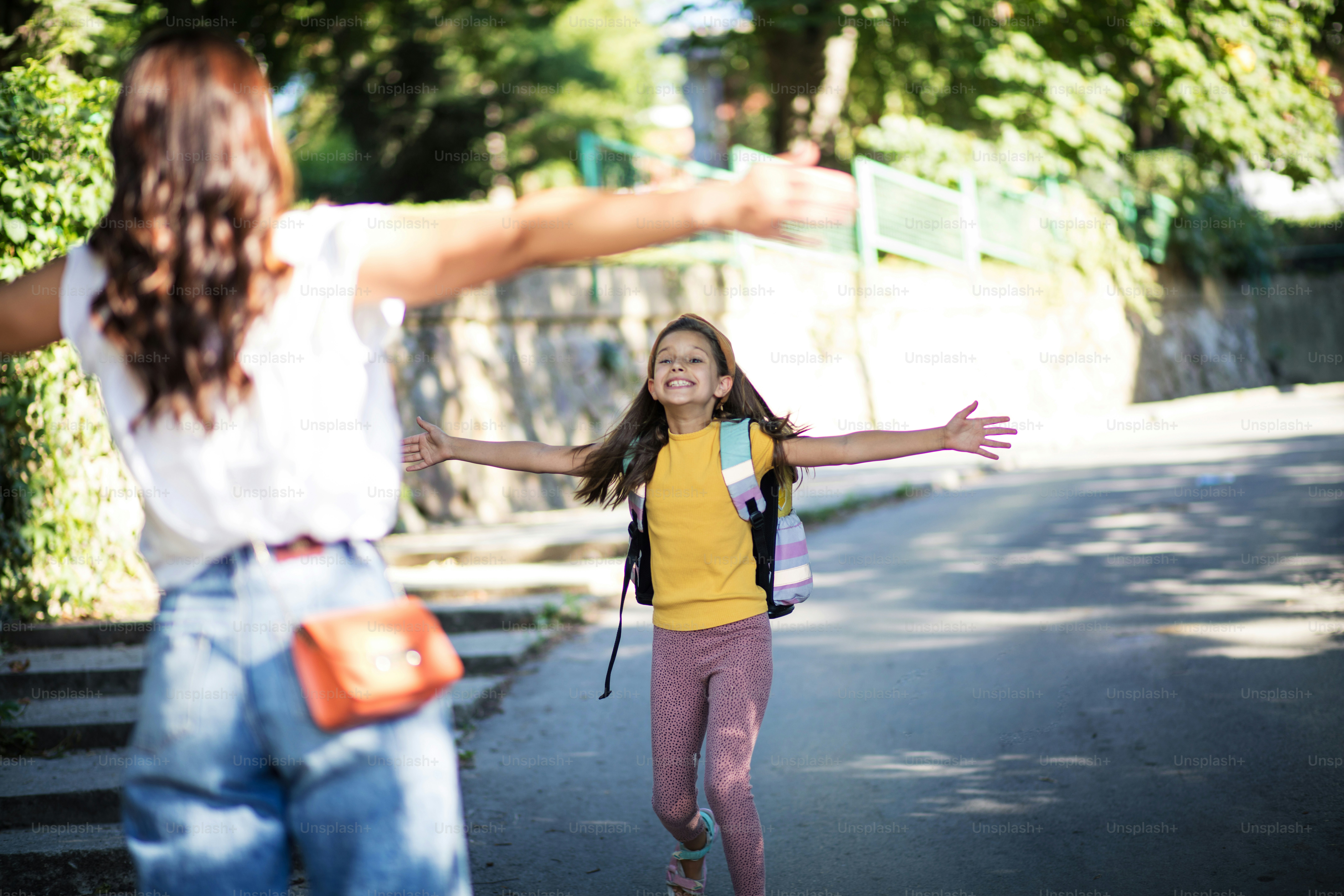 Hug for mom. Little school girl running in to mother hug. photo ...