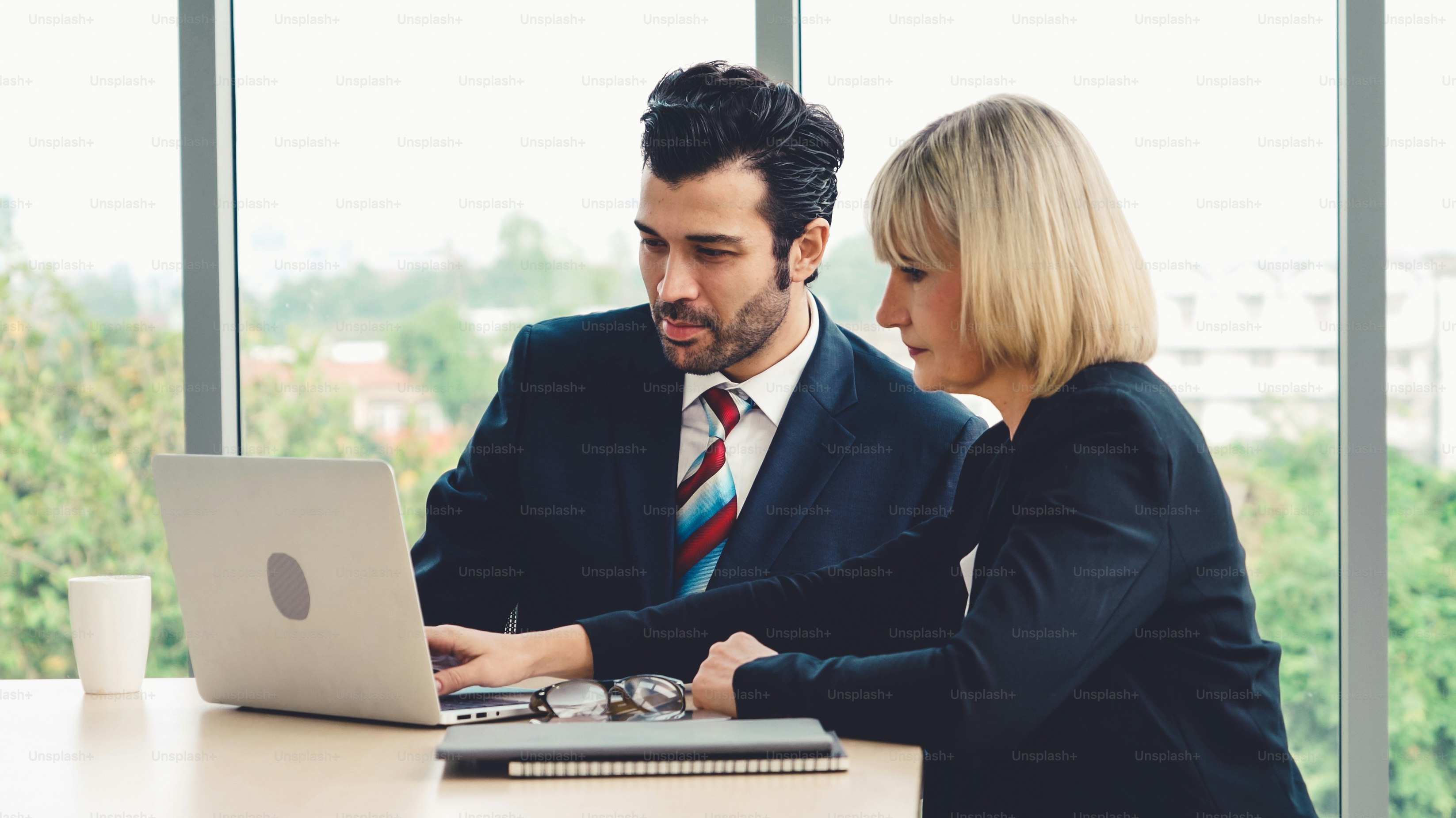 Two business people talk project strategy at office meeting room ...