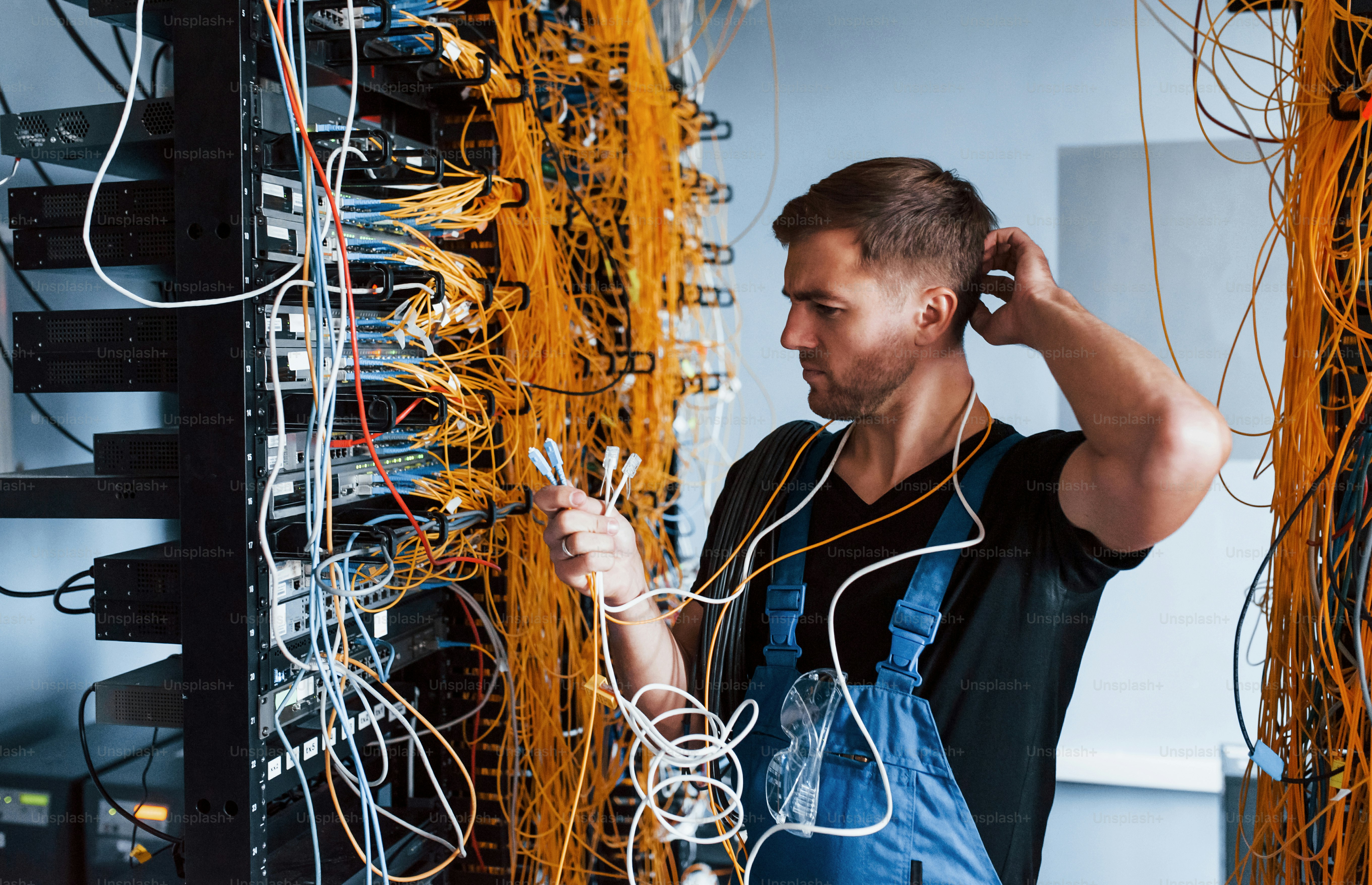 Young man in uniform with measuring device works with internet ...