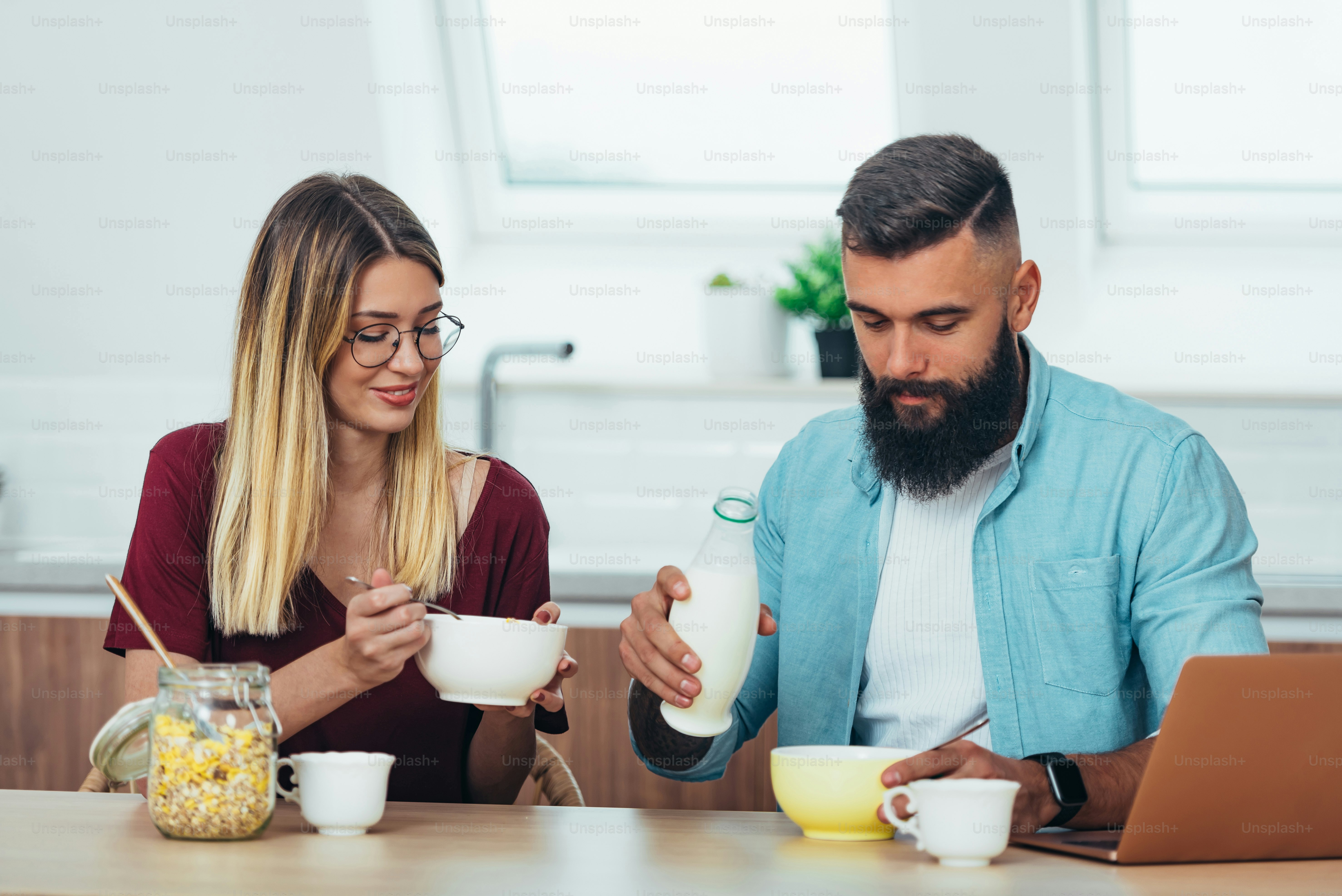 Shot of a happy young couple making breakfast together at home photo ...