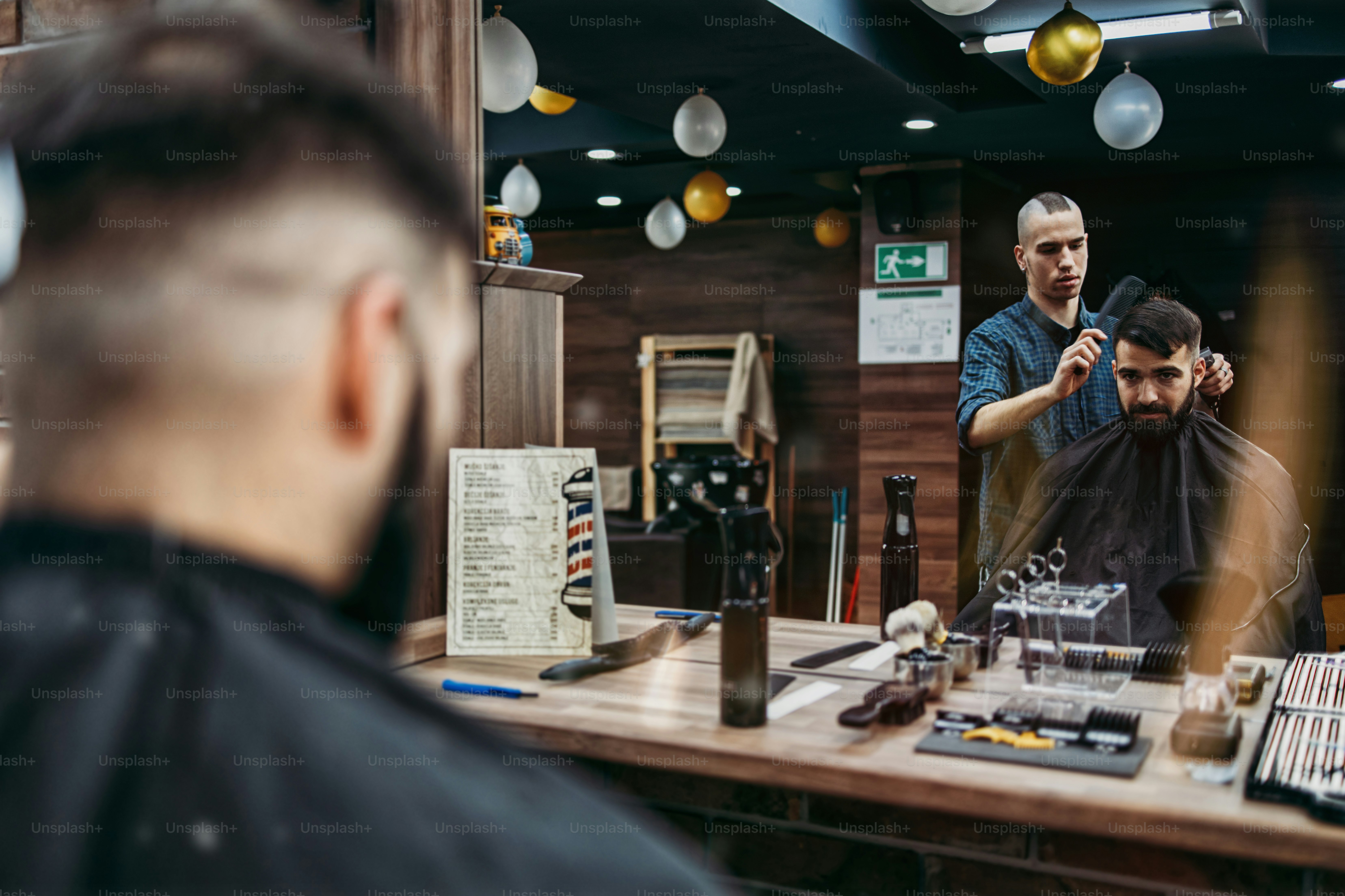 Good looking young adult man getting a hair and beard styling and ...