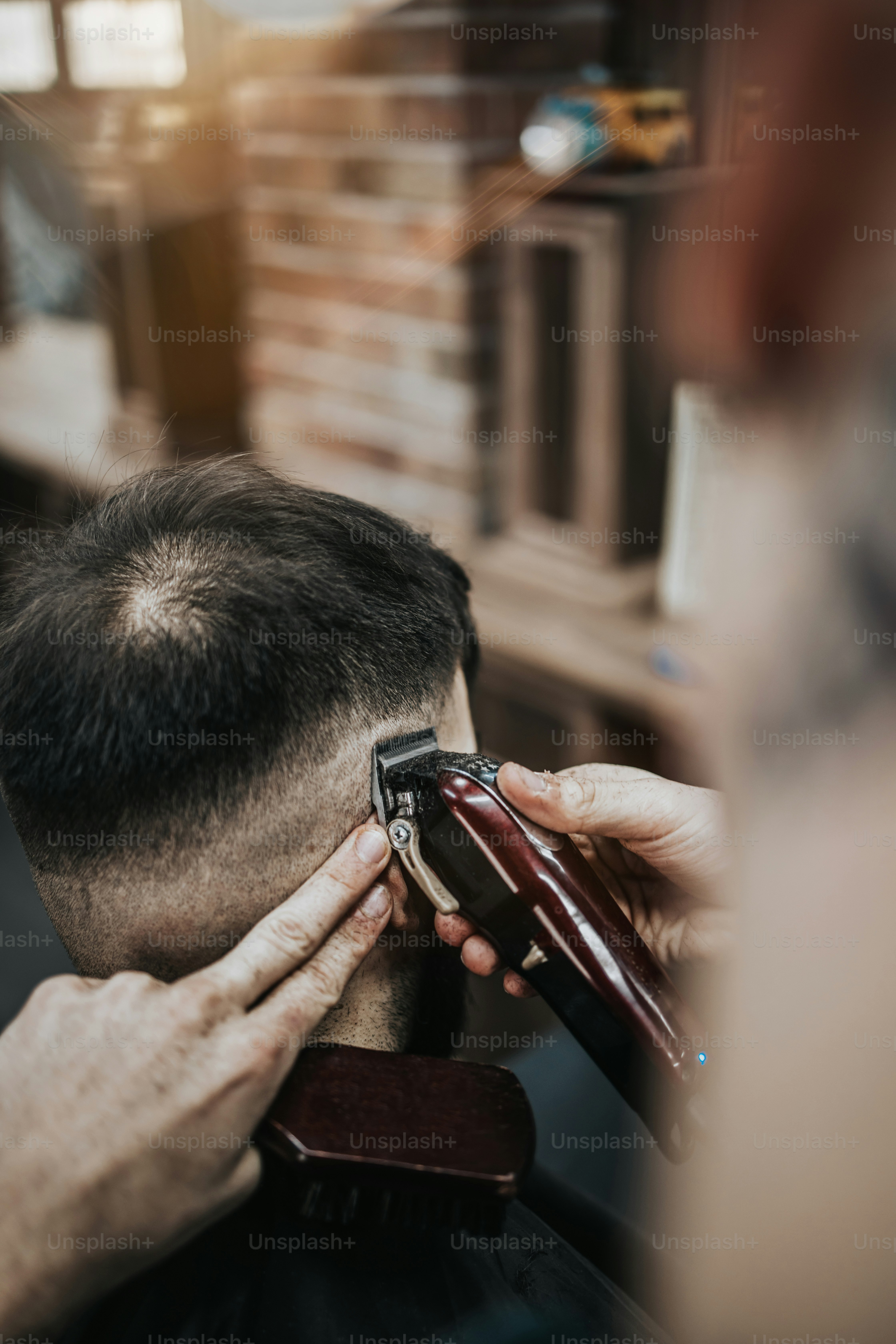 Good looking young adult man getting a hair and beard styling and ...