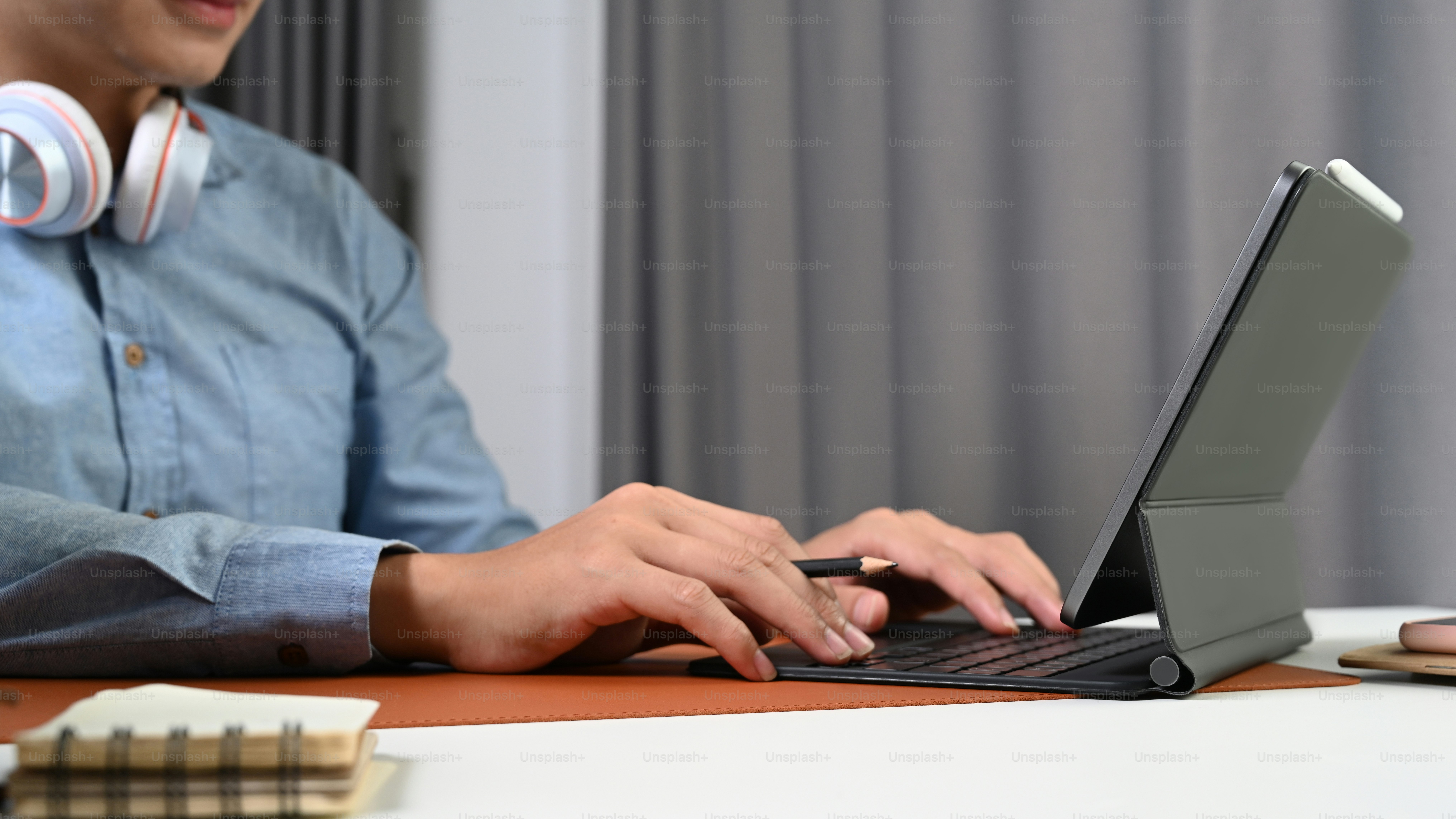 Cropped shot of young man freelancer with headphone working online on ...