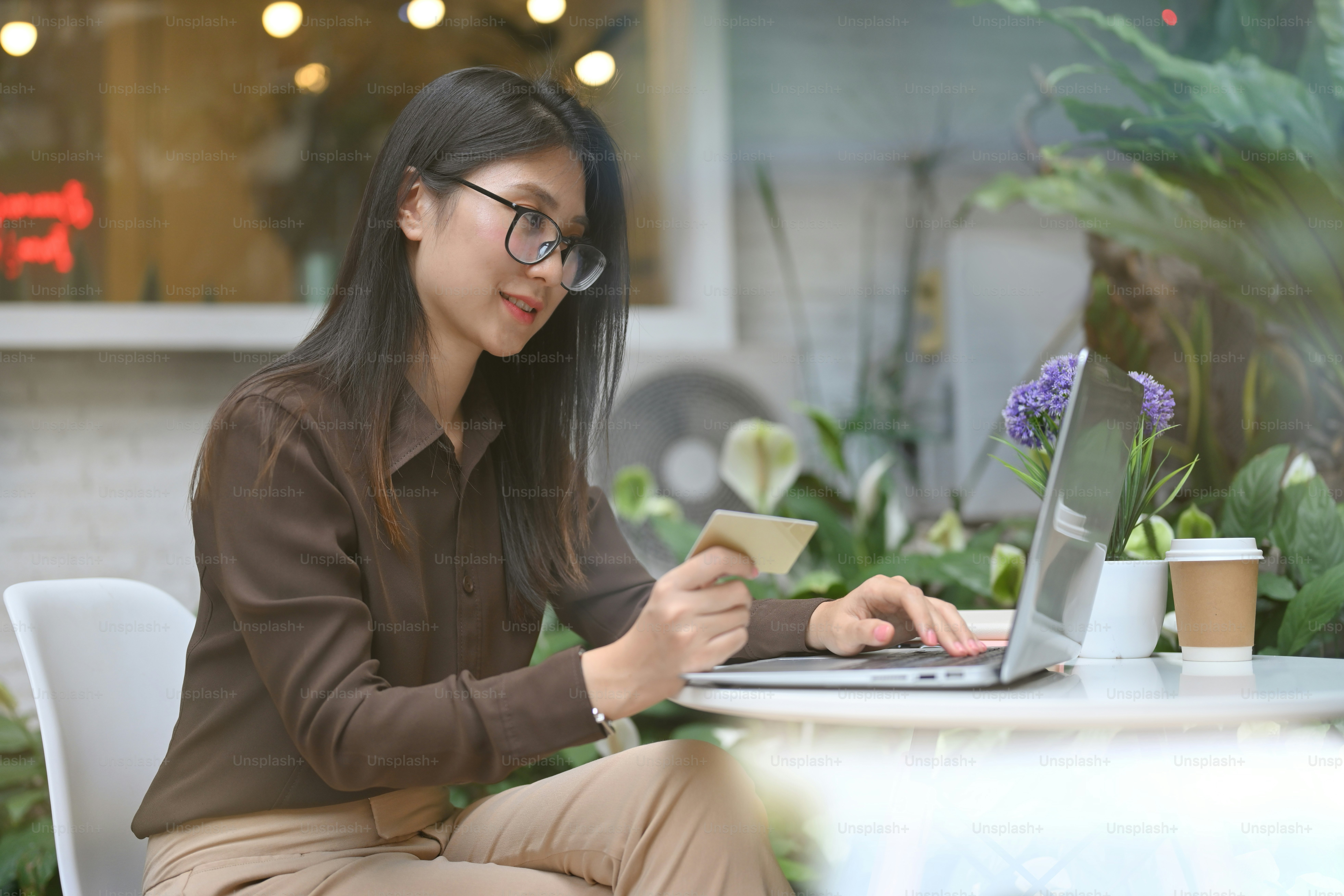 Side view of female office worker doing online banking on laptop while ...