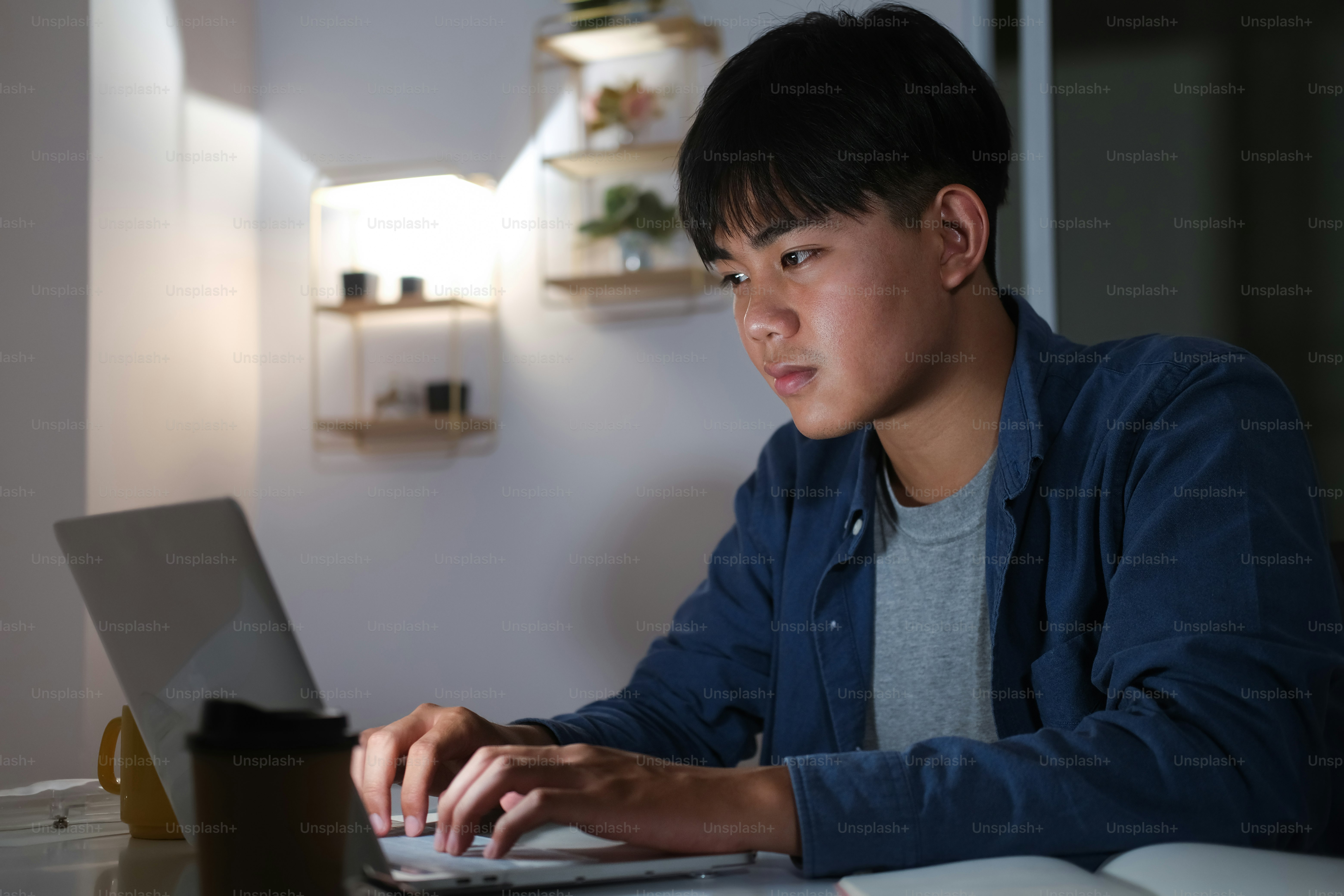 Young collage man learning online at night at his home. photo – 20-24 ...