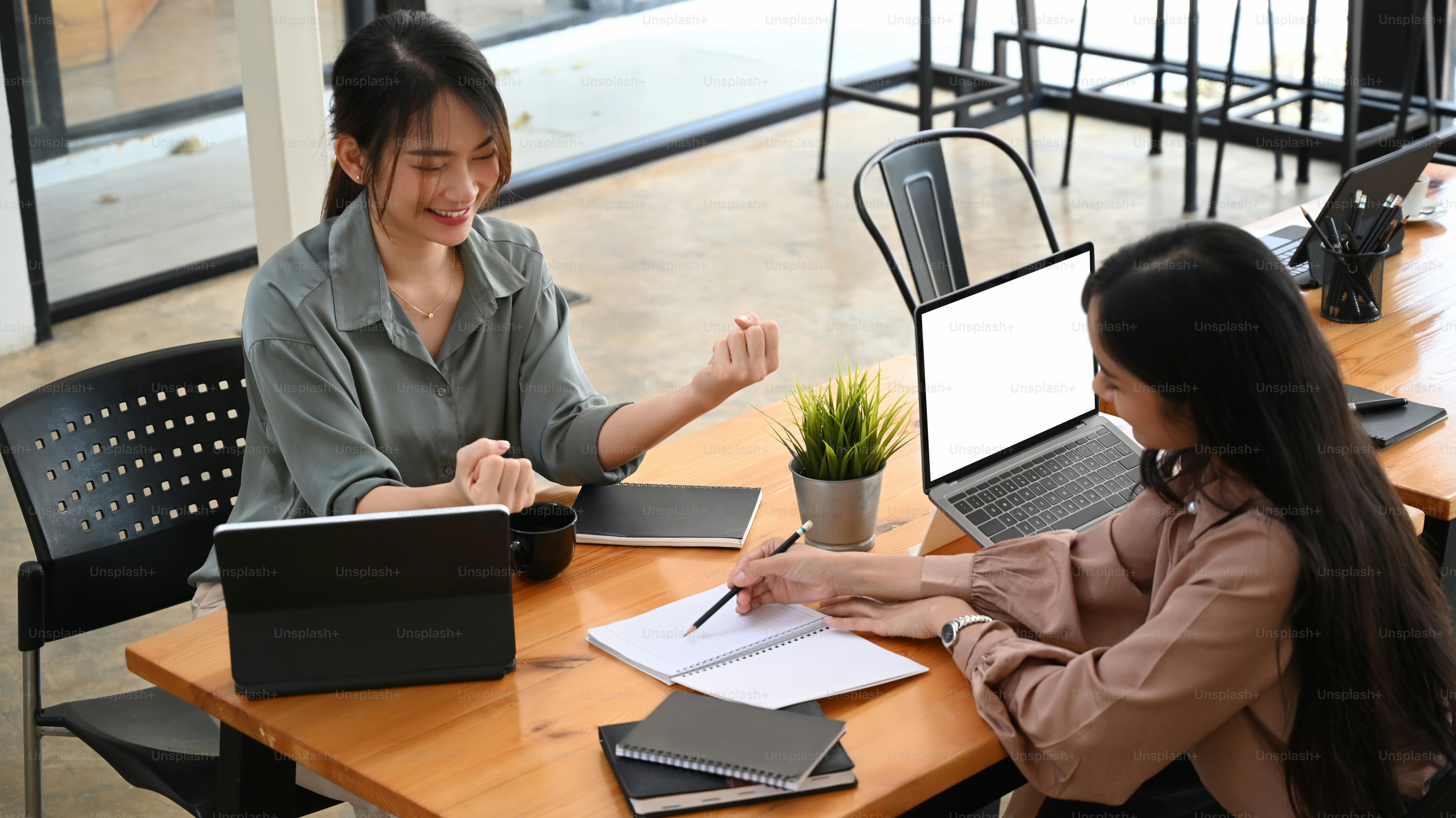Two successful businesswoman working together in modern office. photo ...