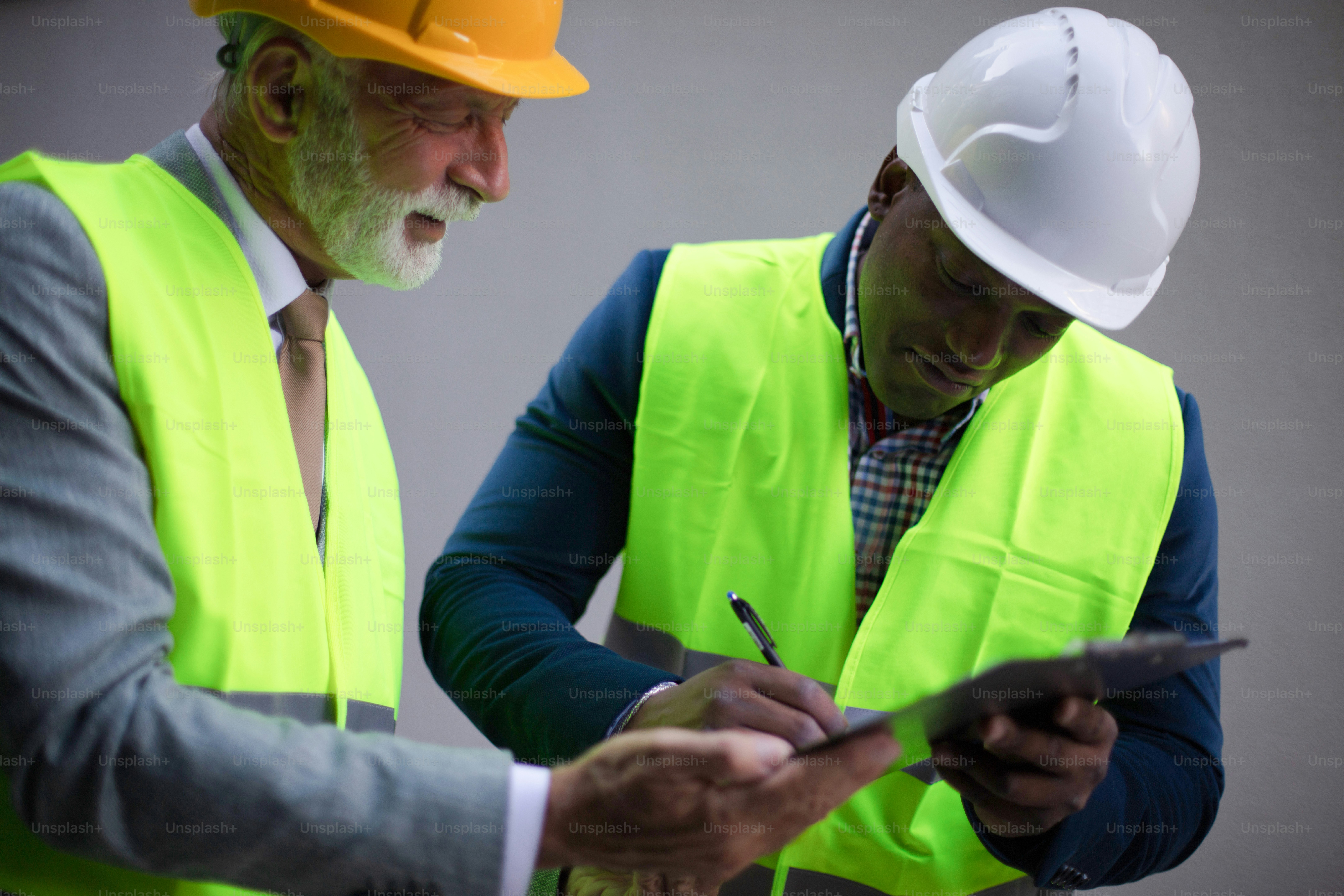Signing contract. Two engineers on street. photo – Vitality Image on ...