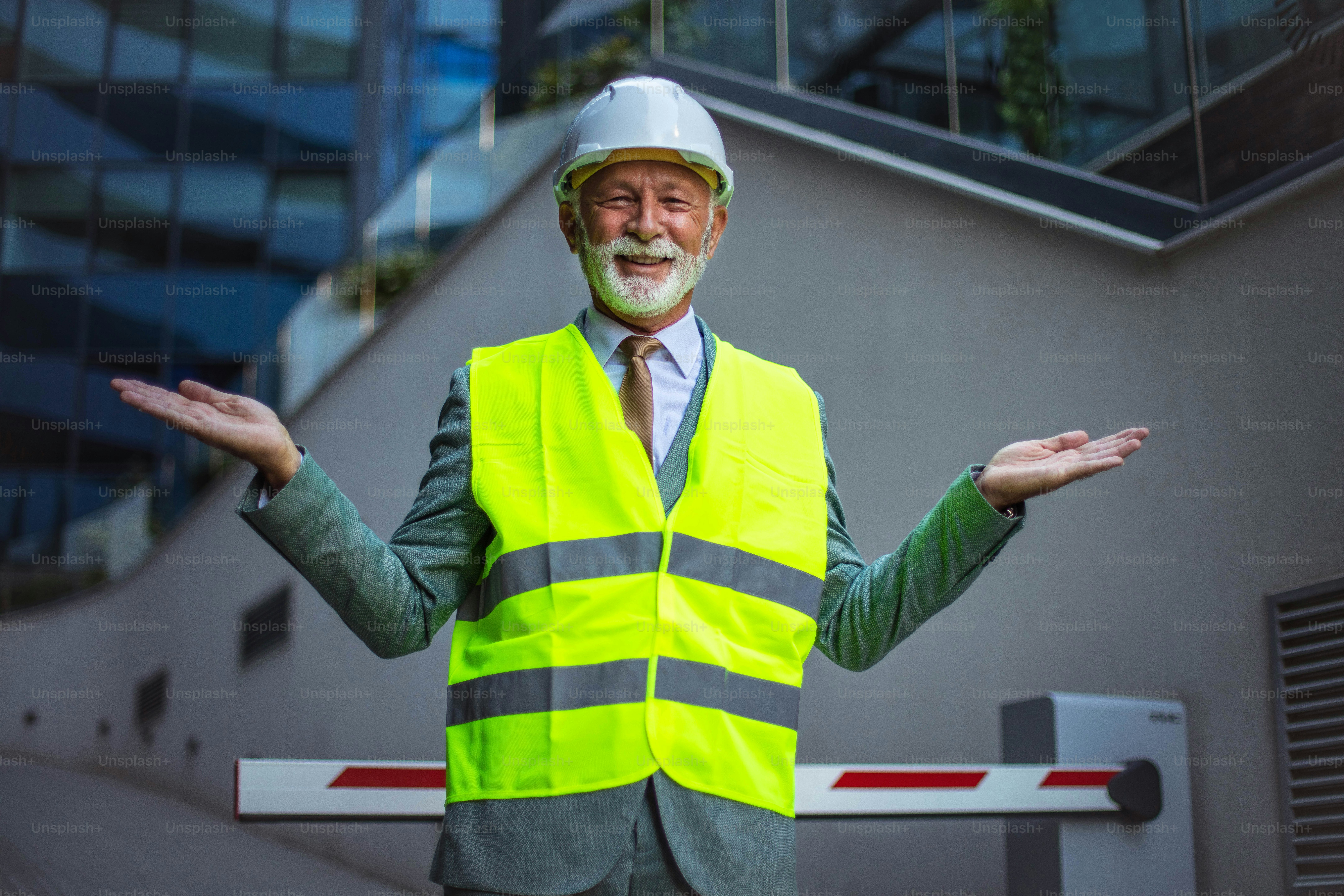 Smiling engineer standing on the street. Looking at camera. photo ...