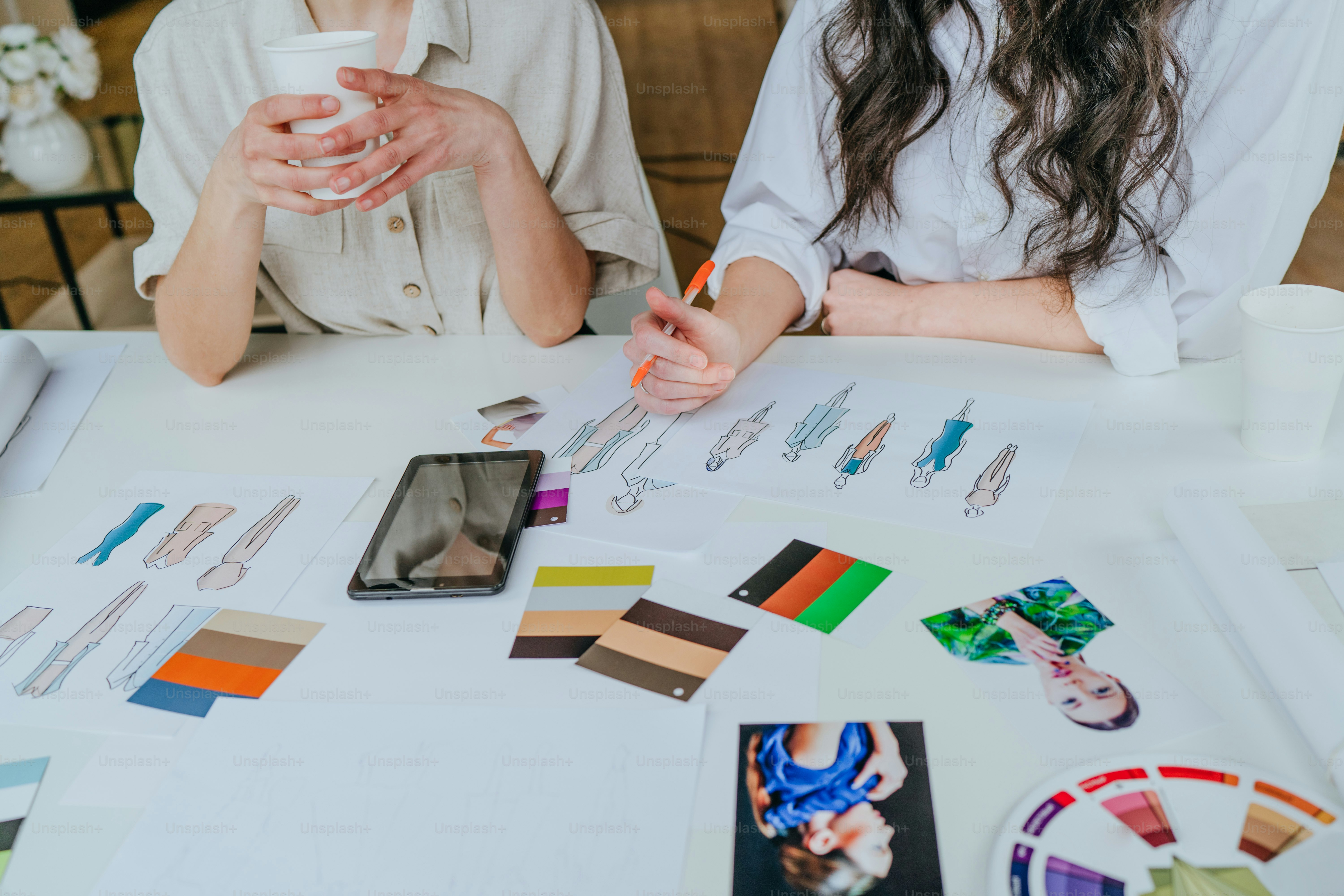 Workspace of designers discussing new clothes models and colour ...