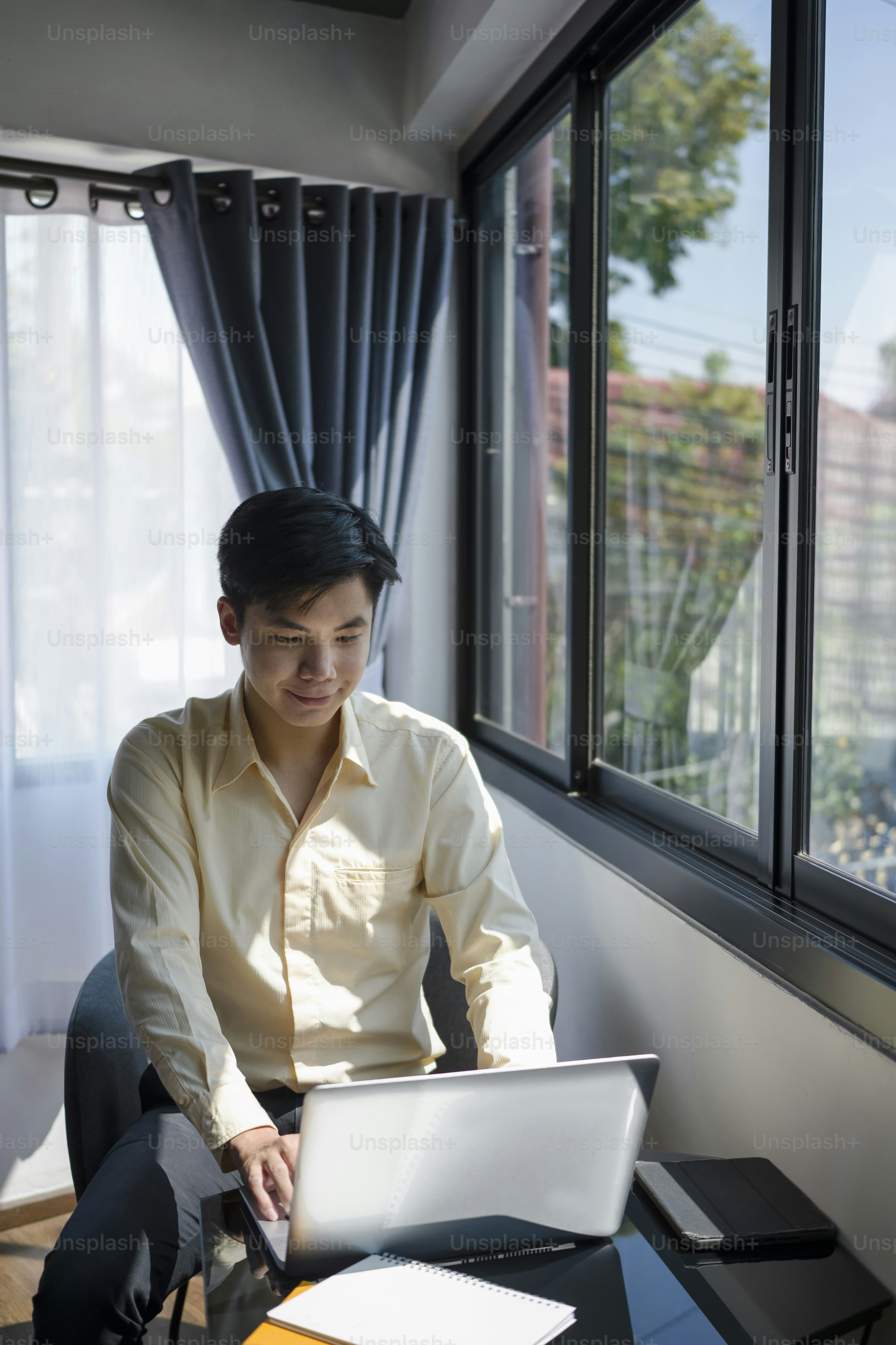 Young business man using his laptop computer on table. photo – Table ...