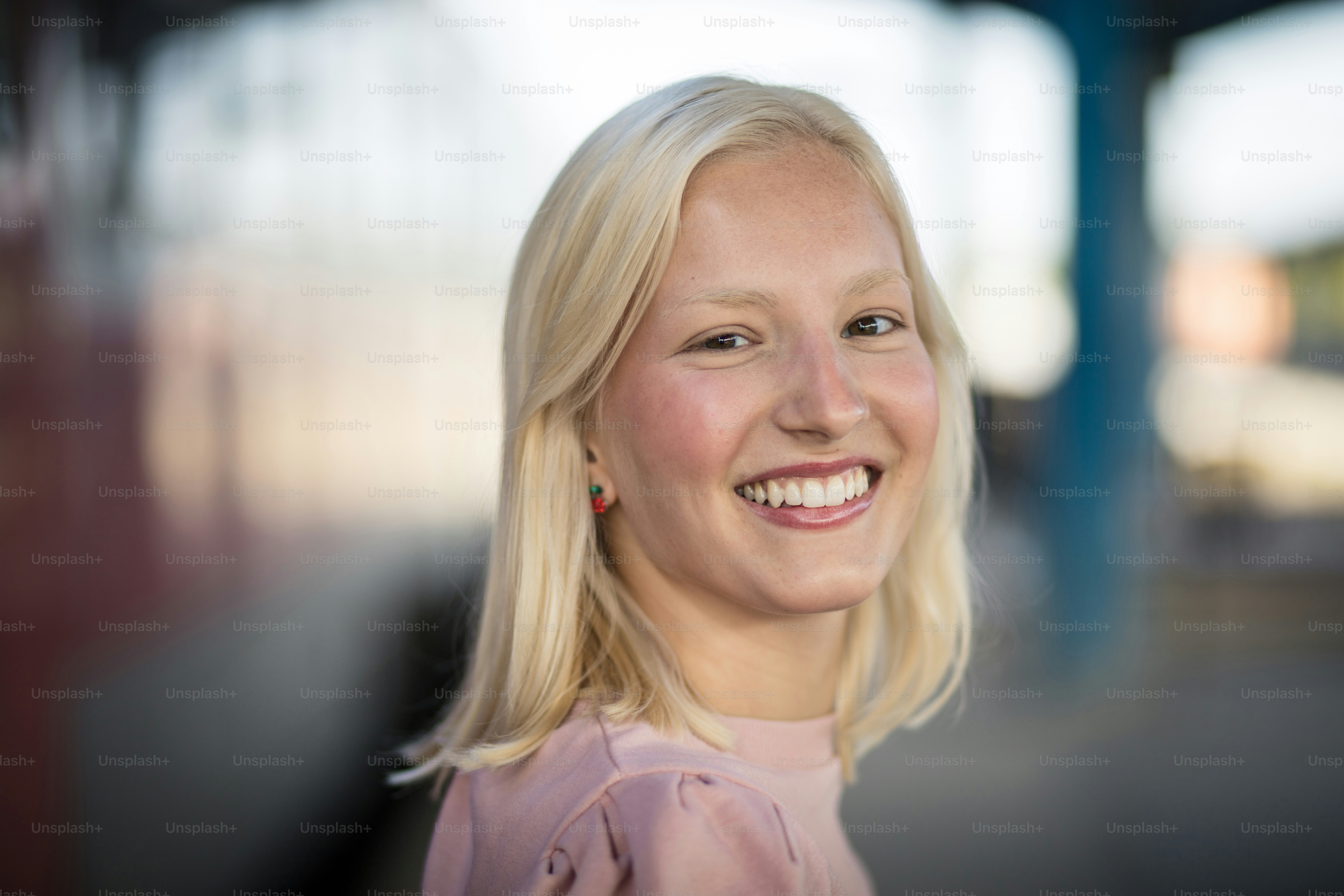Young woman on train station. Looking at camera. photo – One person ...