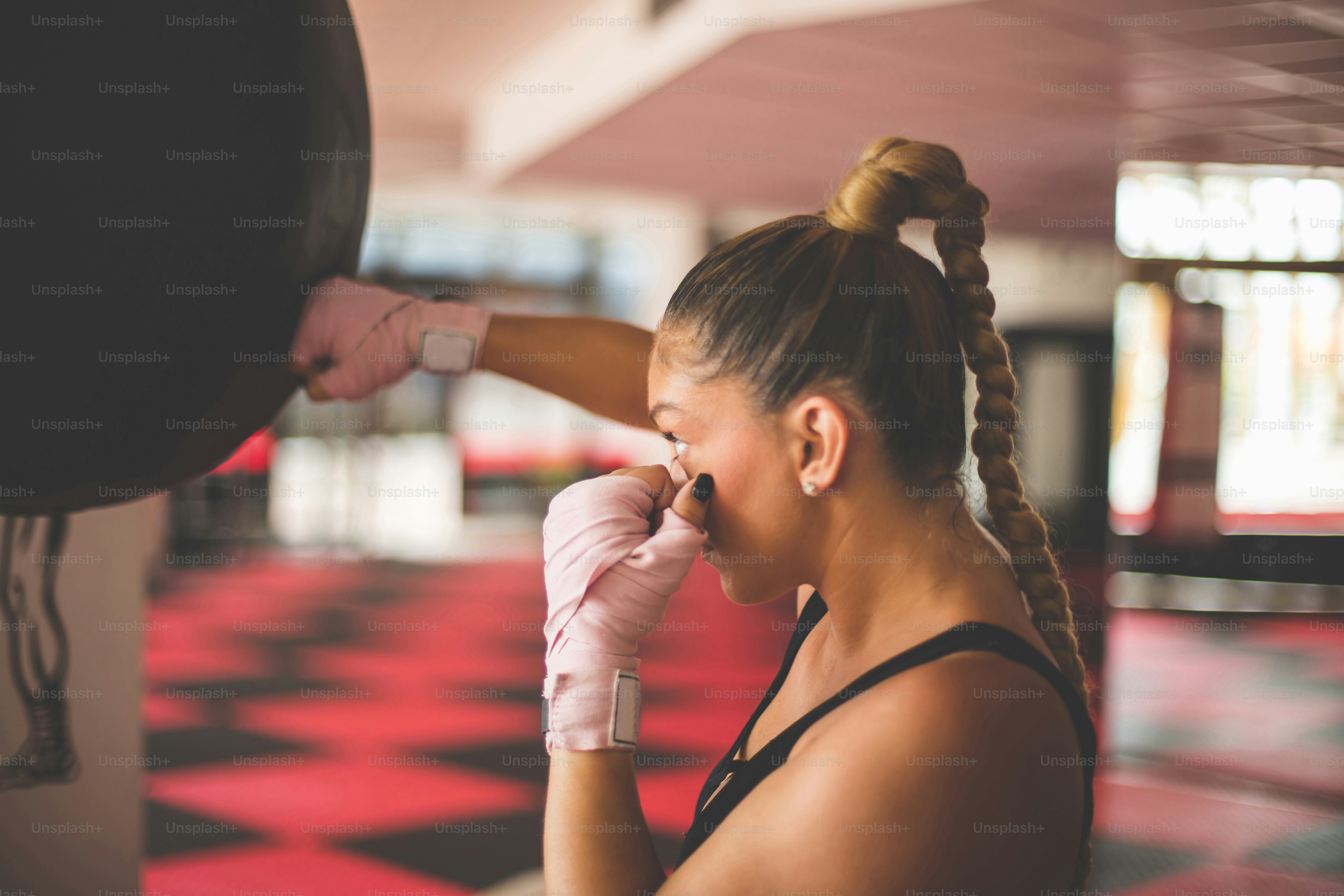 Strong young lady with boxing gloves, punching bag in gym alone. photo ...