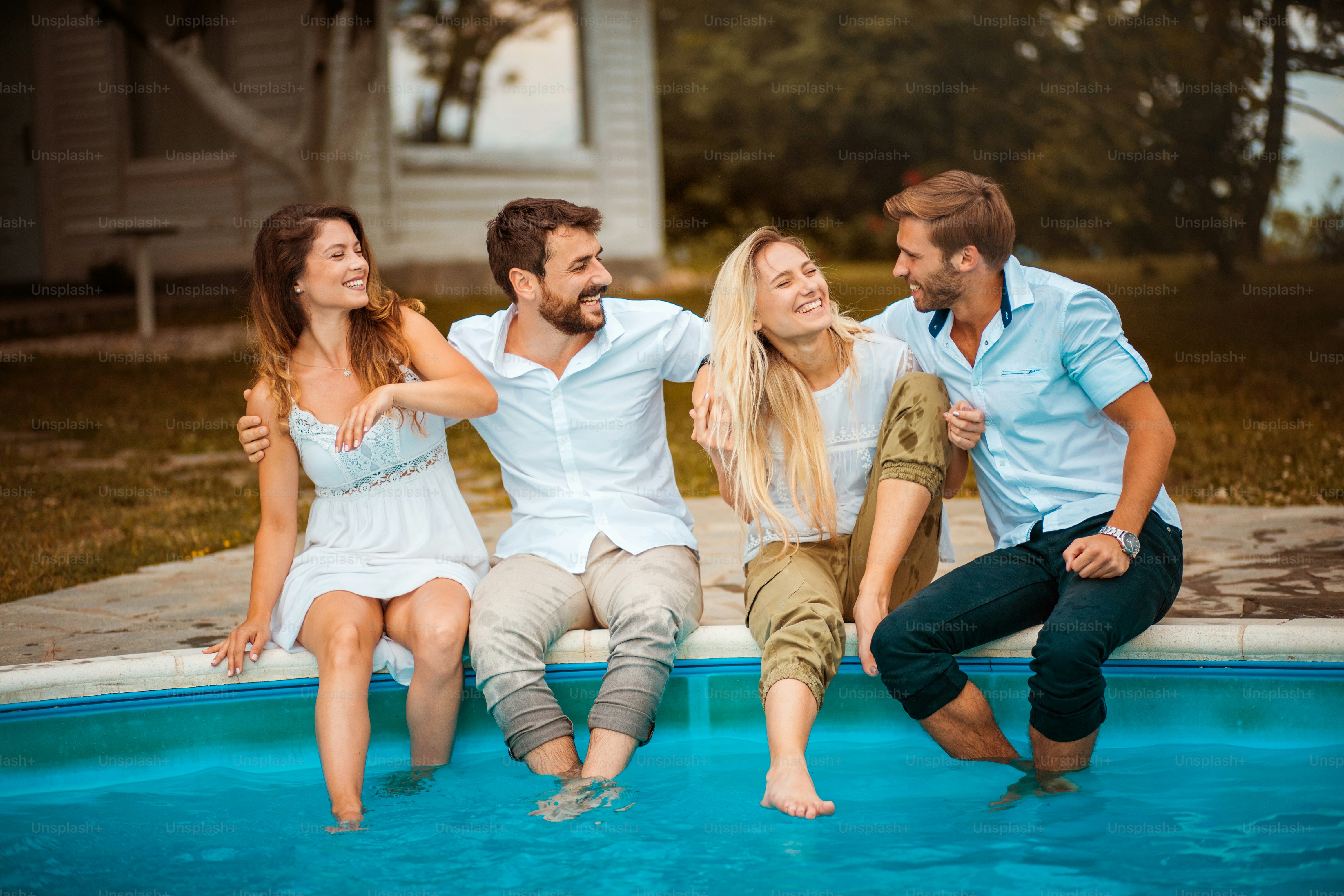 Friends having fun by the pool. photo – Laughing Image on Unsplash