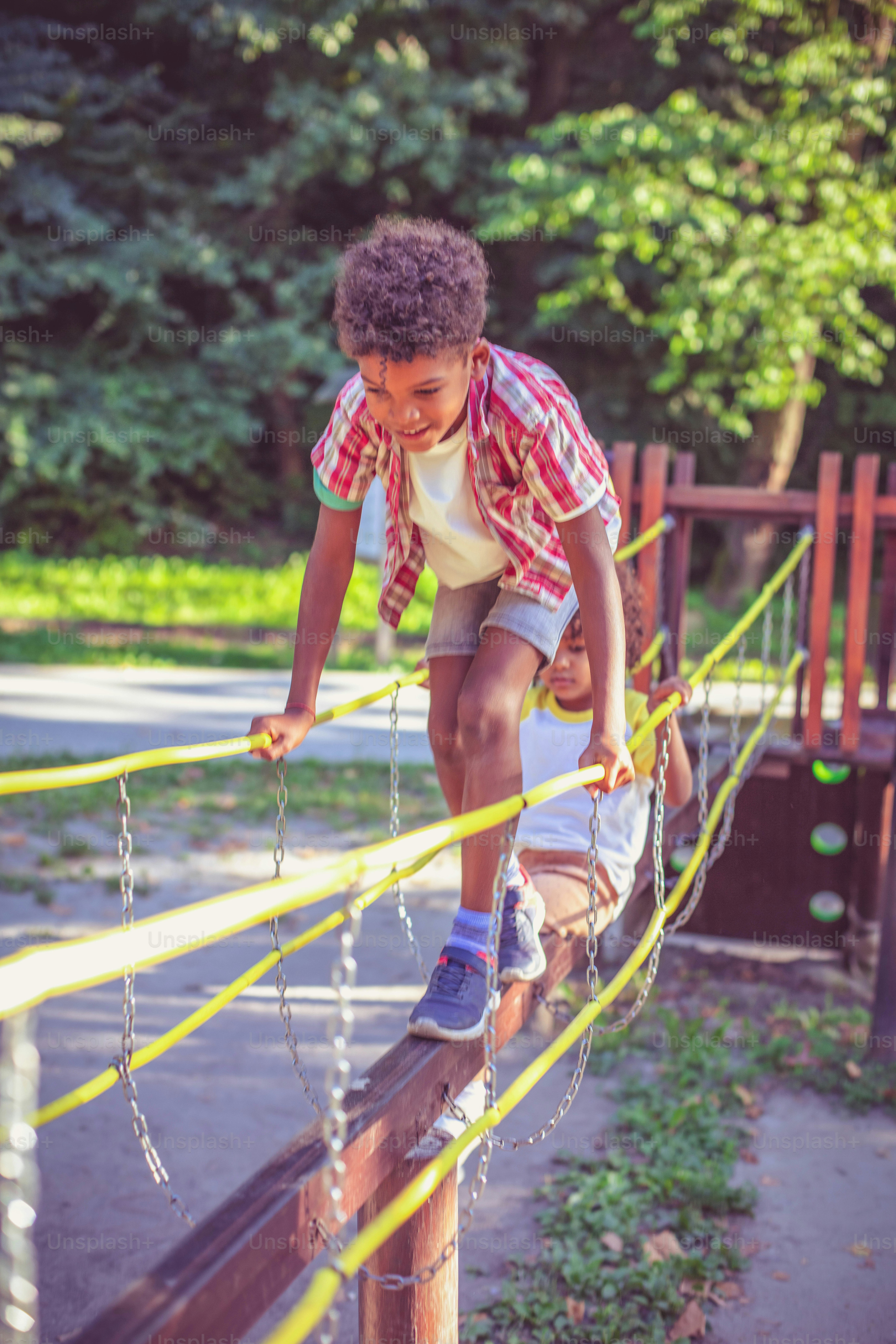 African American kids playing on bridge. photo – Family Image on Unsplash