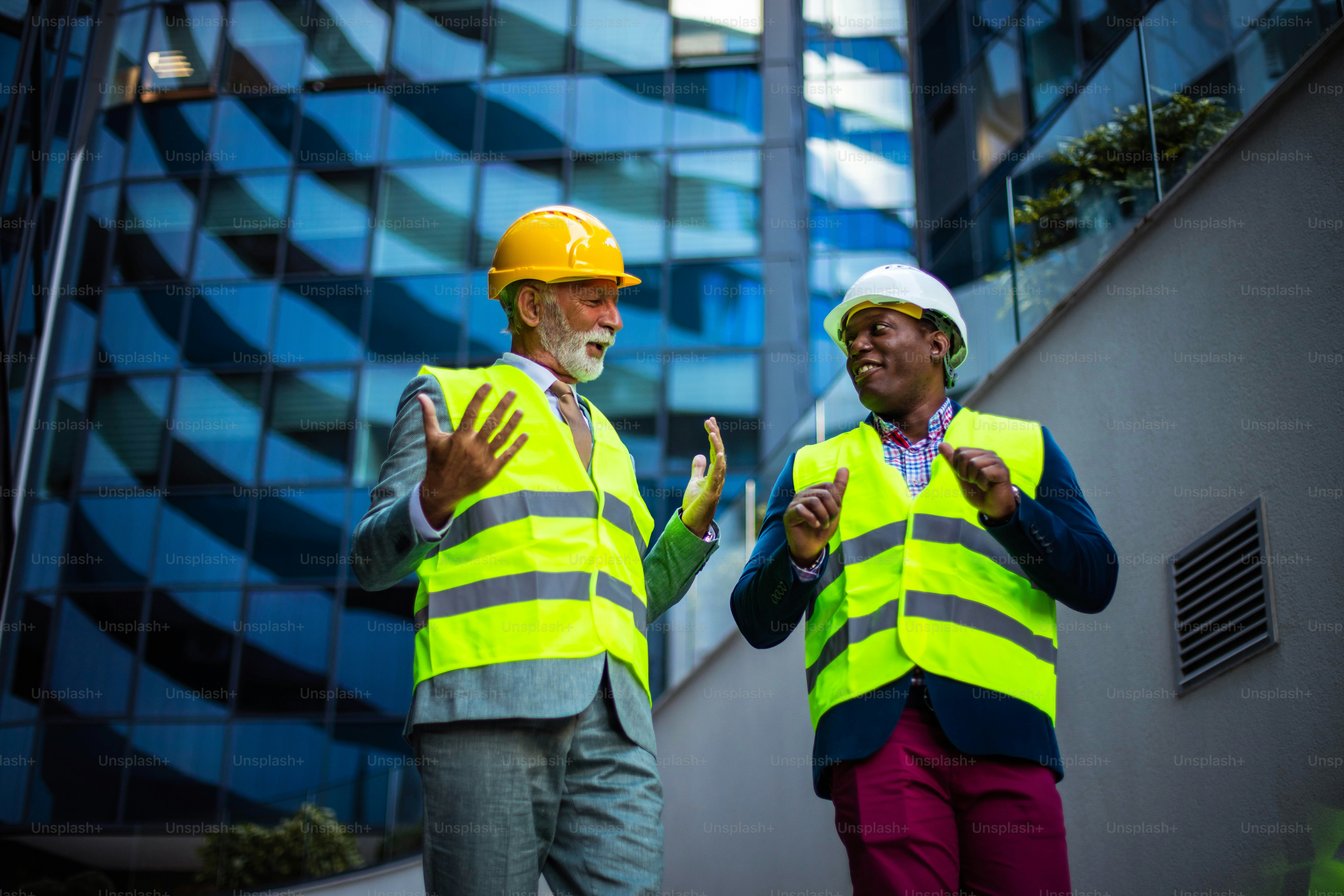 Mature engineer discussing the structure of the building with ...