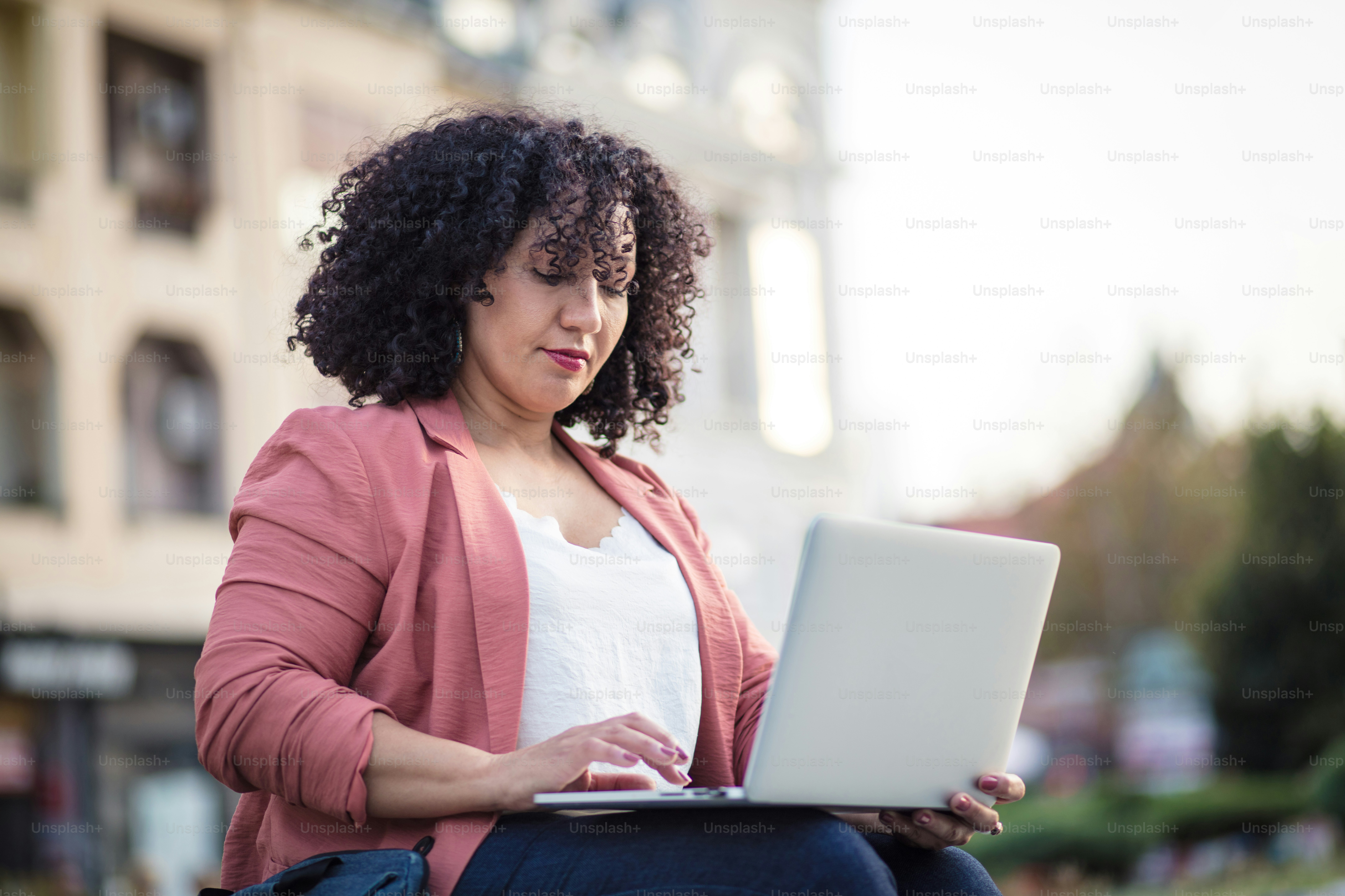 Working woman. Business woman in the street using laptop. photo ...
