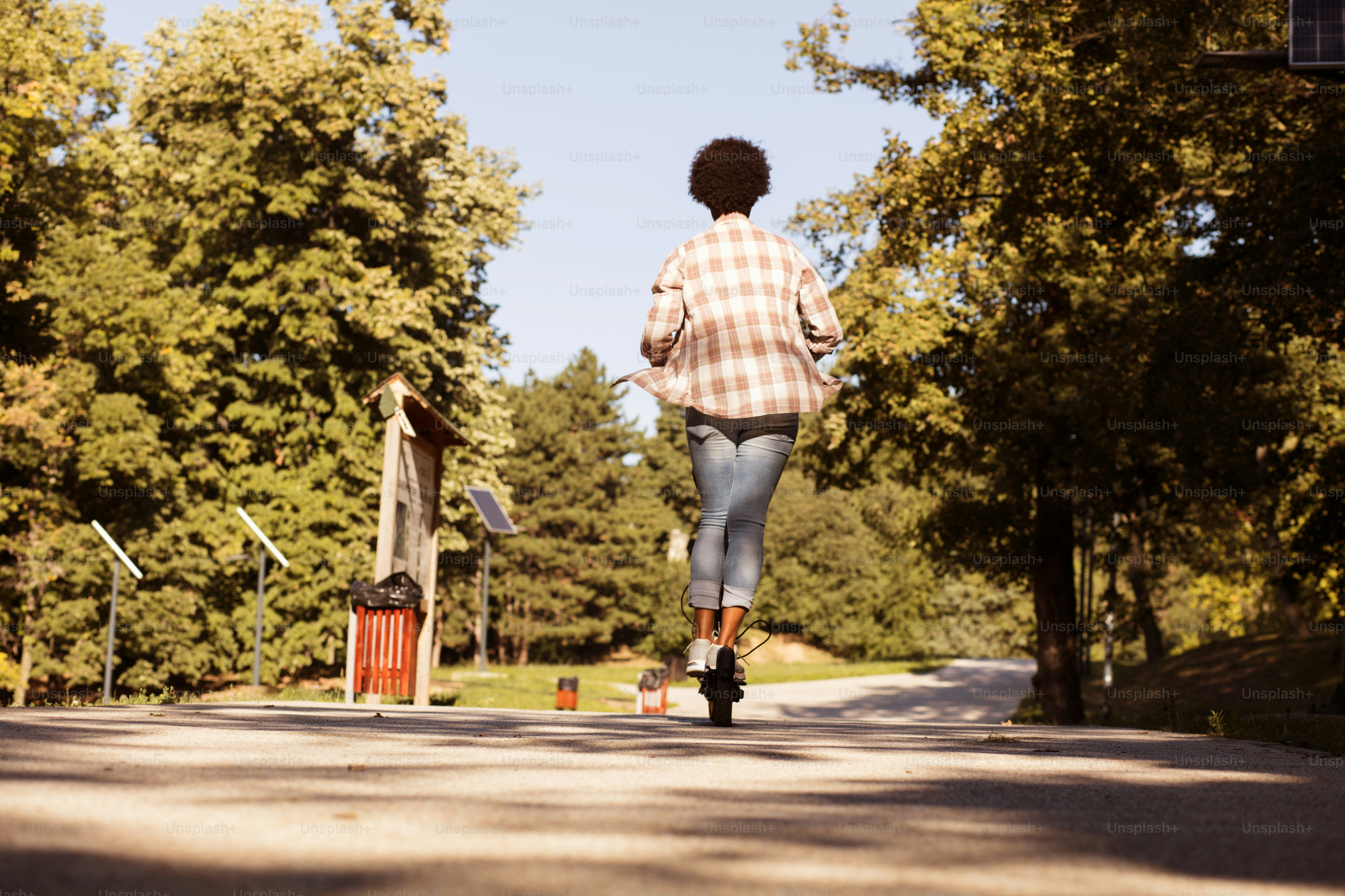 Woman with electric scooter. Women with an electric scooter in the park ...