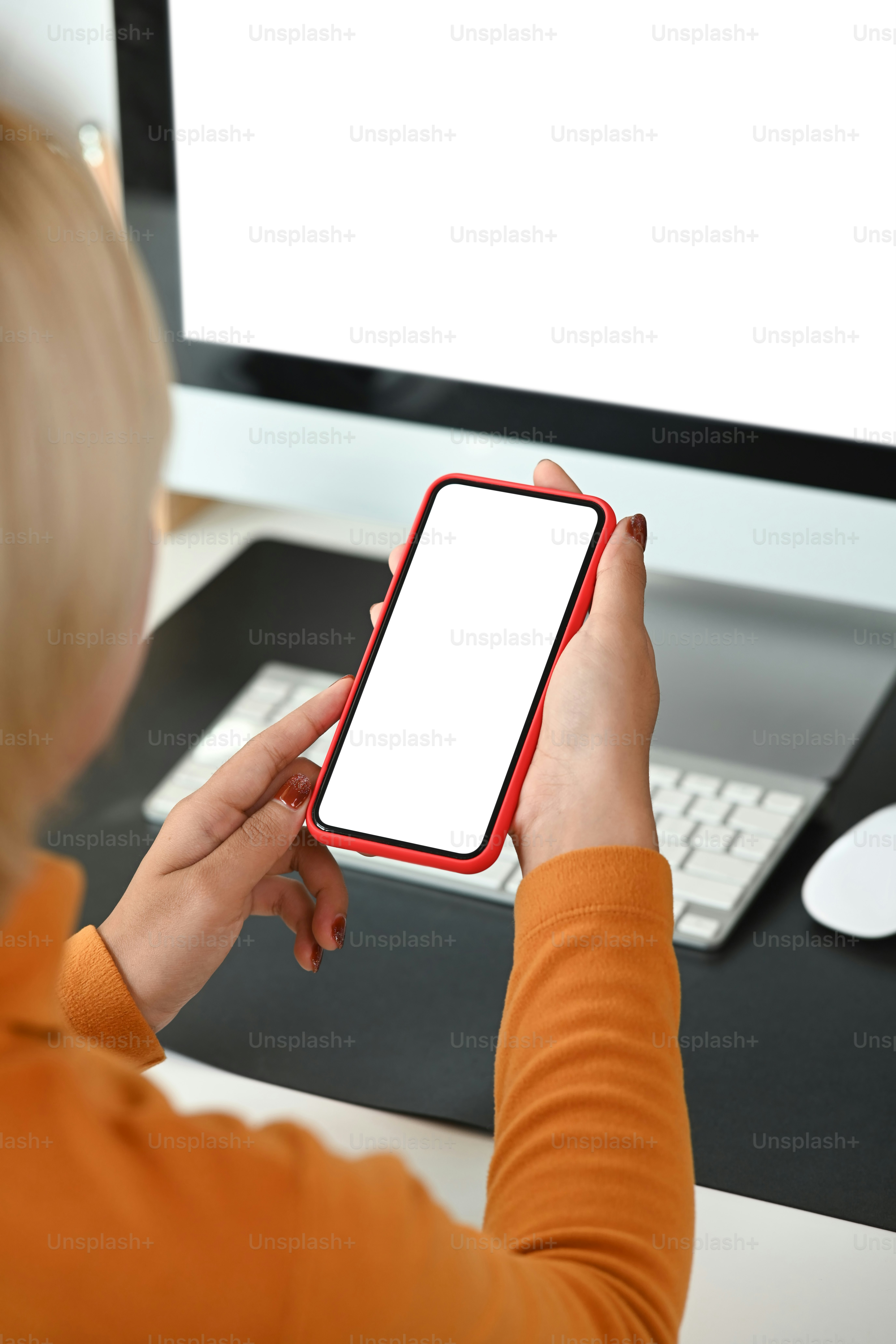 Close up over shoulder view of young designer using mobile phone while ...