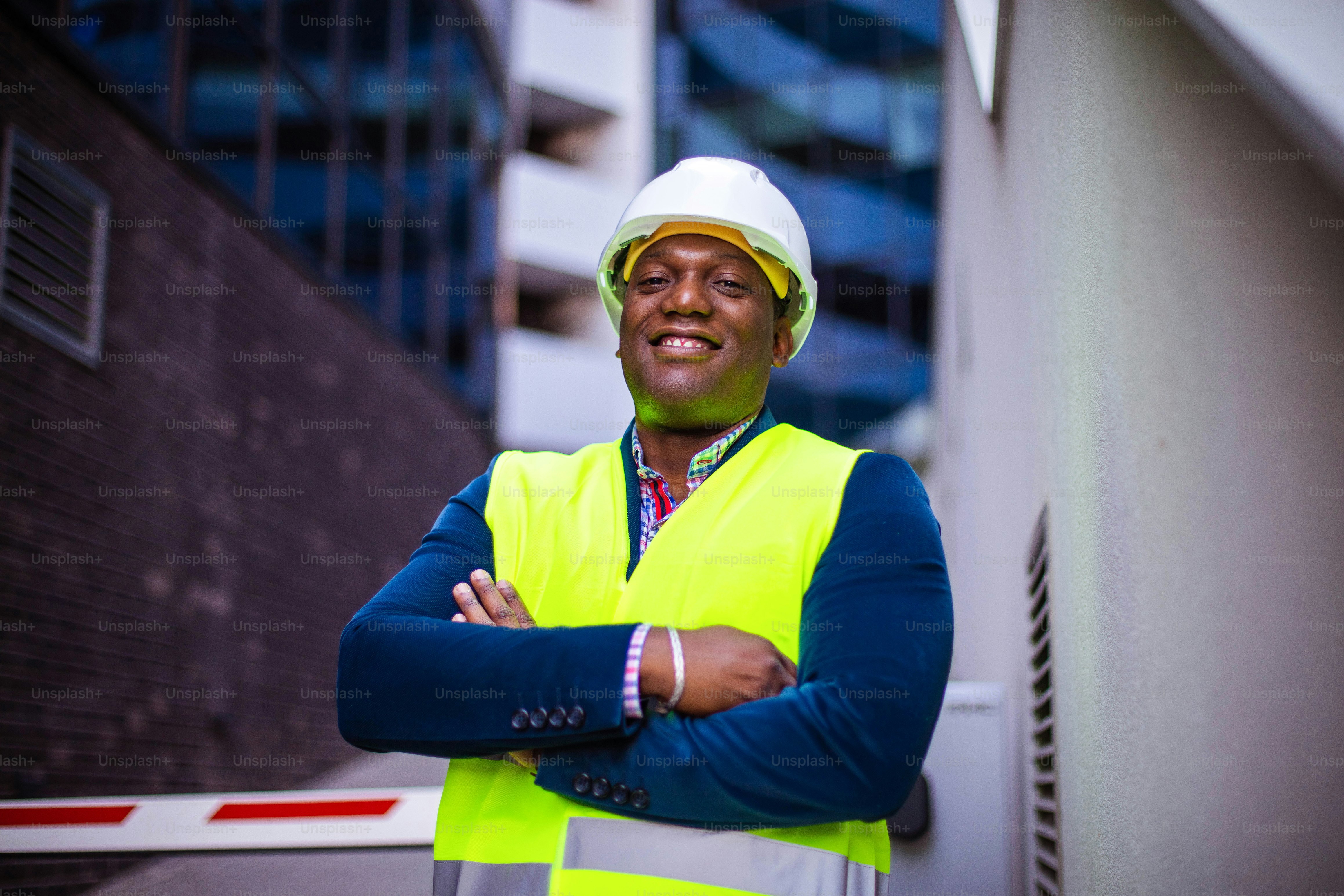Smiling engineer standing on the street. photo – Black men Image on ...