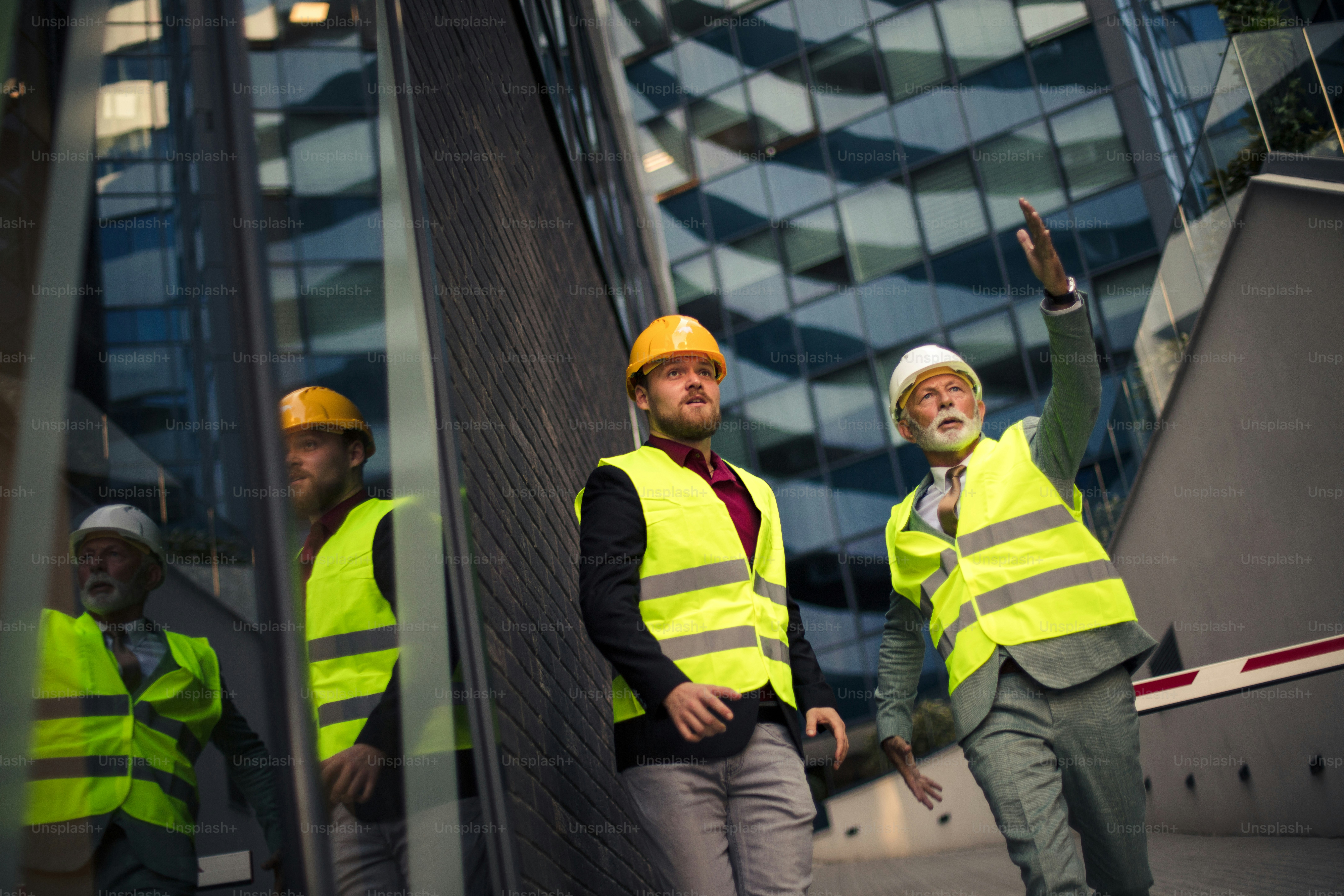 Mature engineer discussing the structure of the building with ...