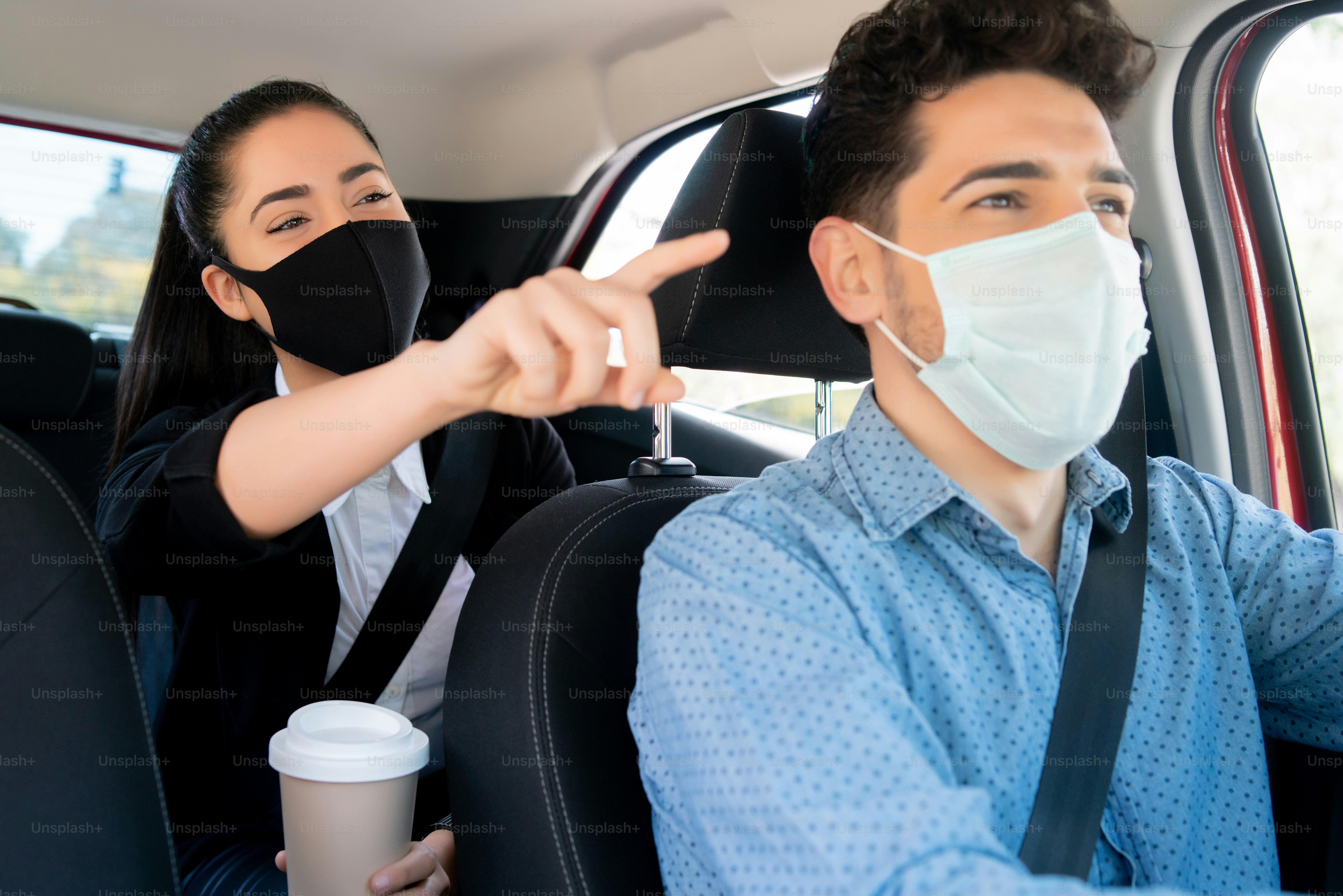 Portrait of business woman pointing something to her taxi driver. New ...