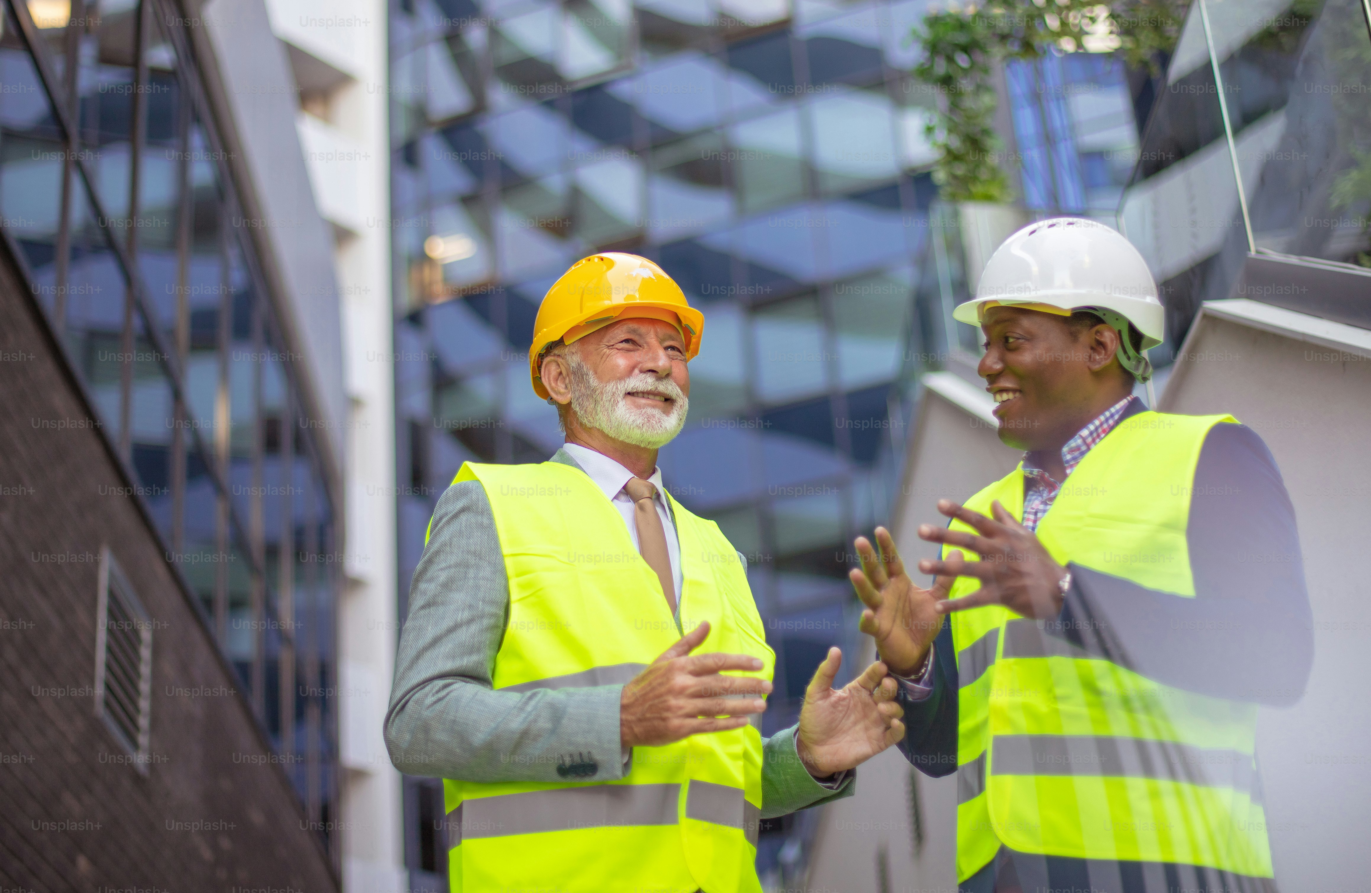 Mature engineer discussing the structure of the building with ...