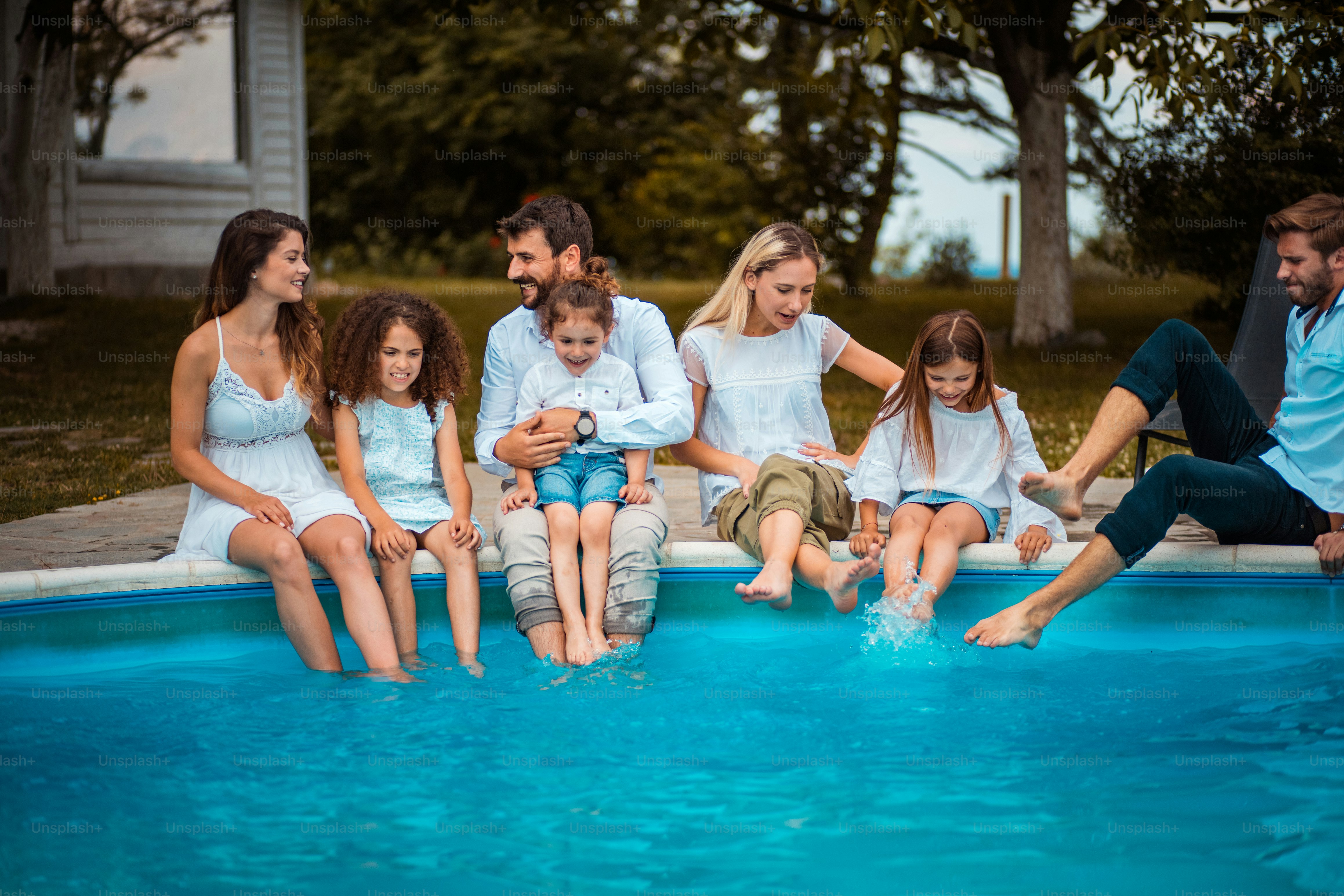 Large group of people sitting by the swimming pool. photo – Serbia ...
